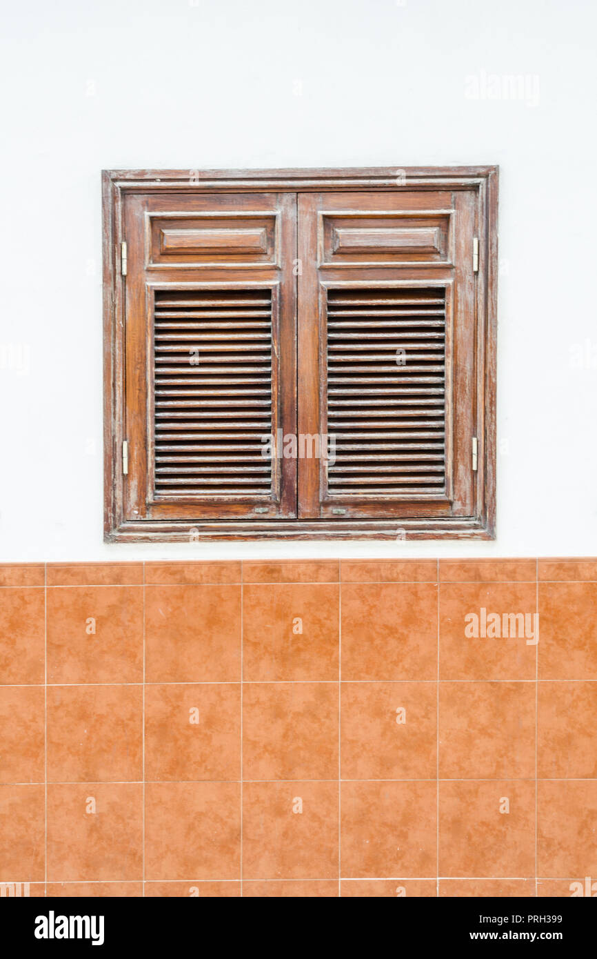 a brown window shutter on a white facade Stock Photo - Alamy