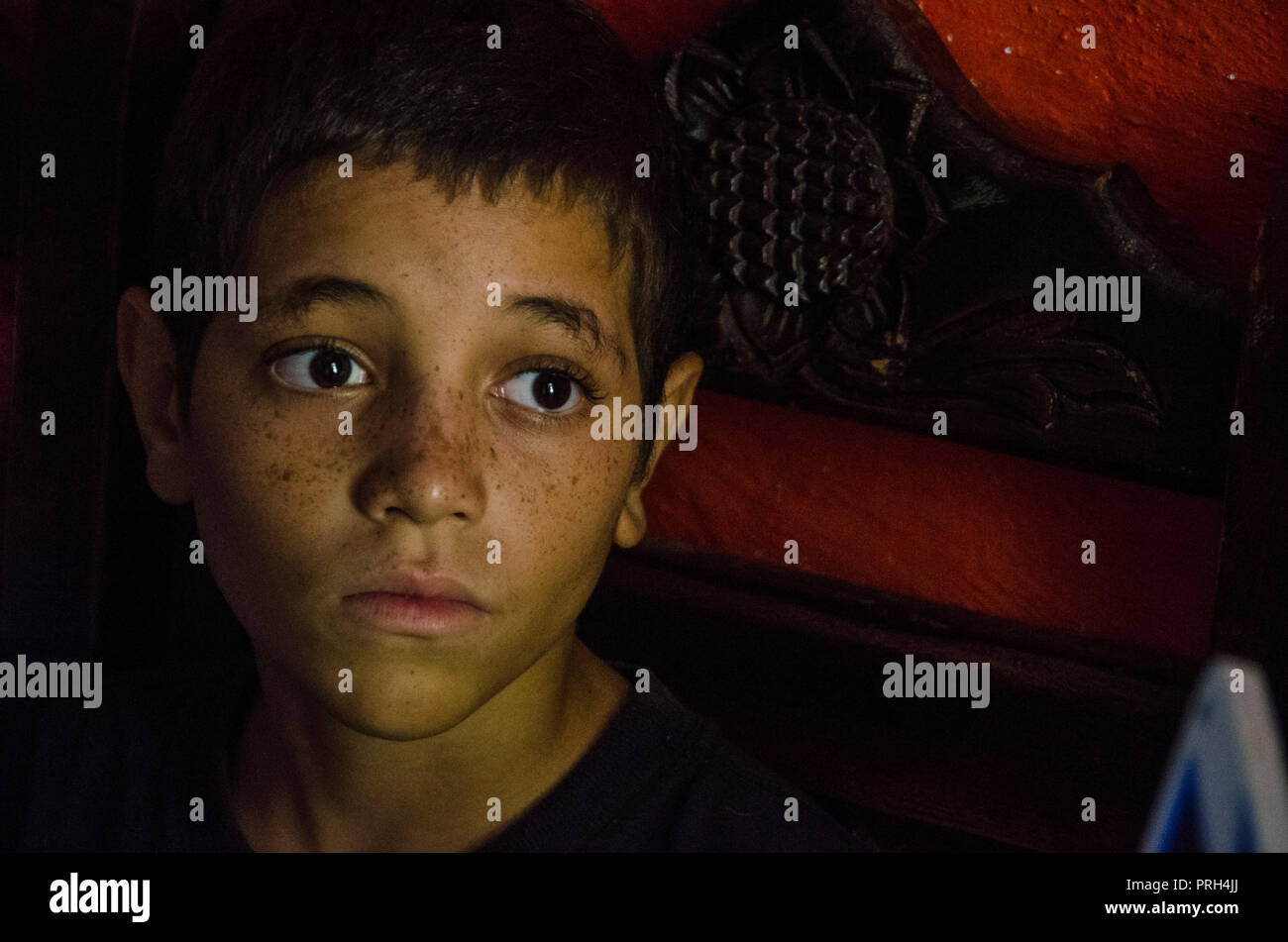 A boy looks from inside his rural house, near Caracas Stock Photo - Alamy