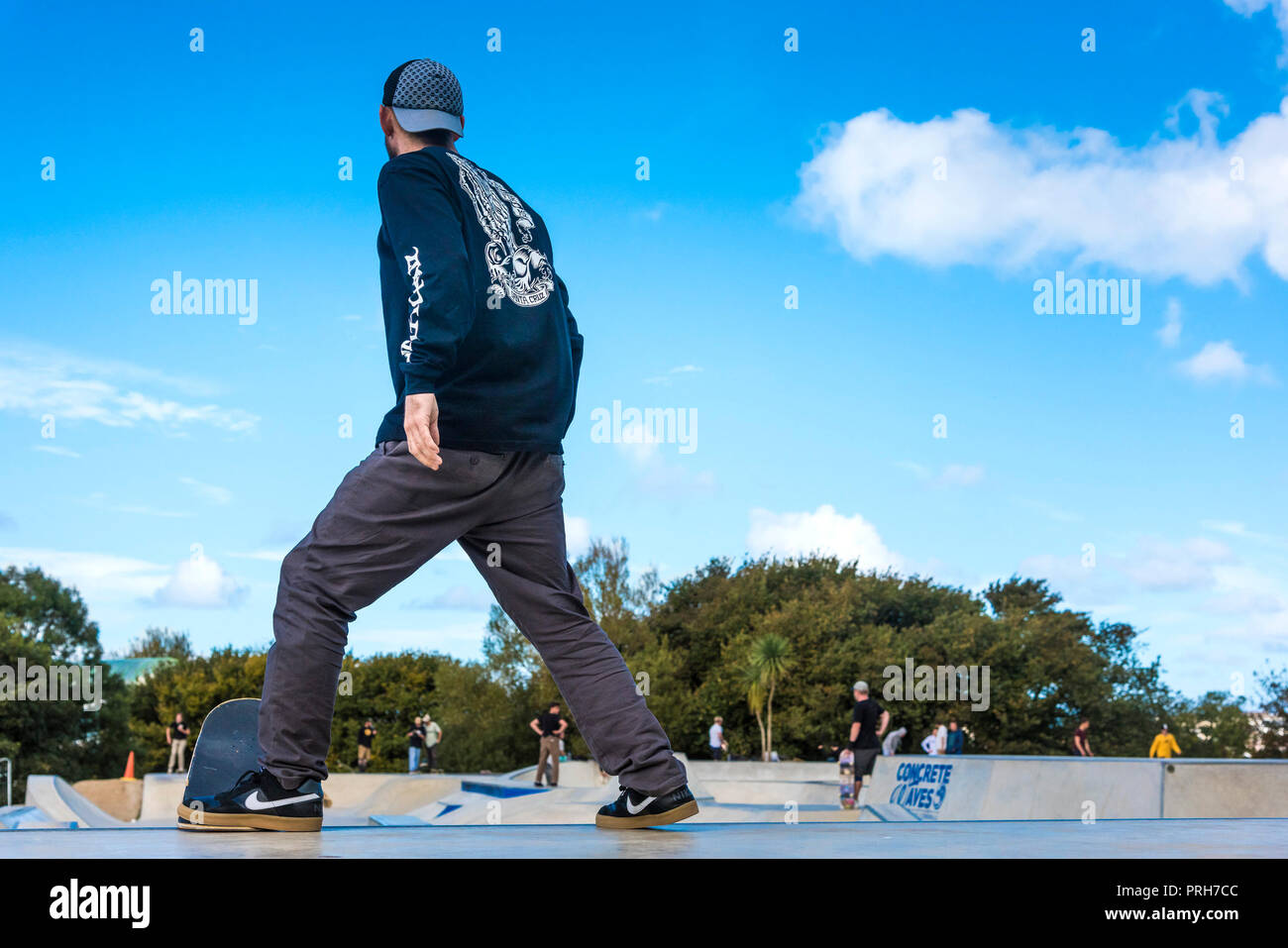 A skateboarders about to push off from a deck at Concrete Waves ...