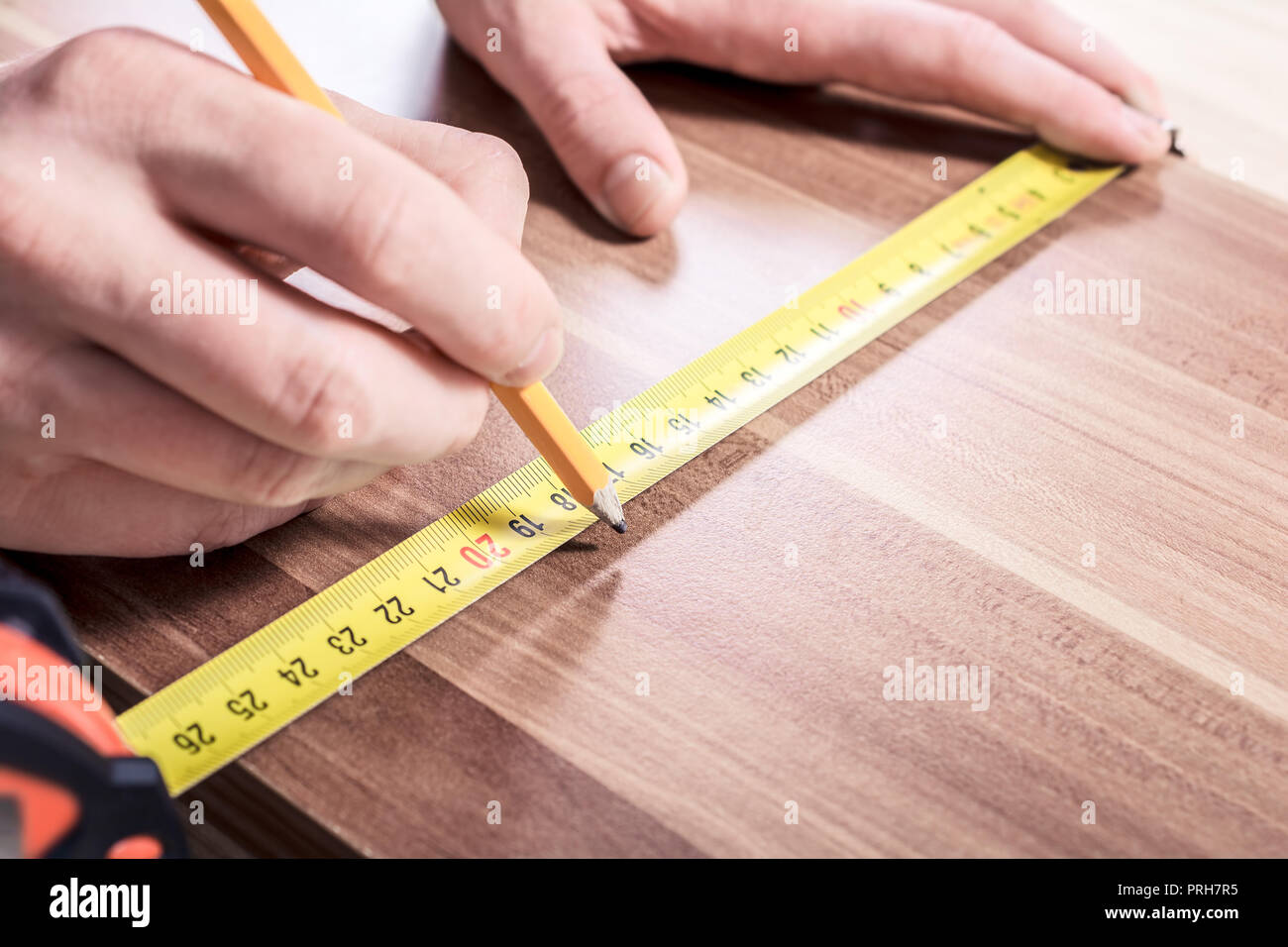 Carpenter Making A Mark With A Pencil After Measuring A Wooden Board ...