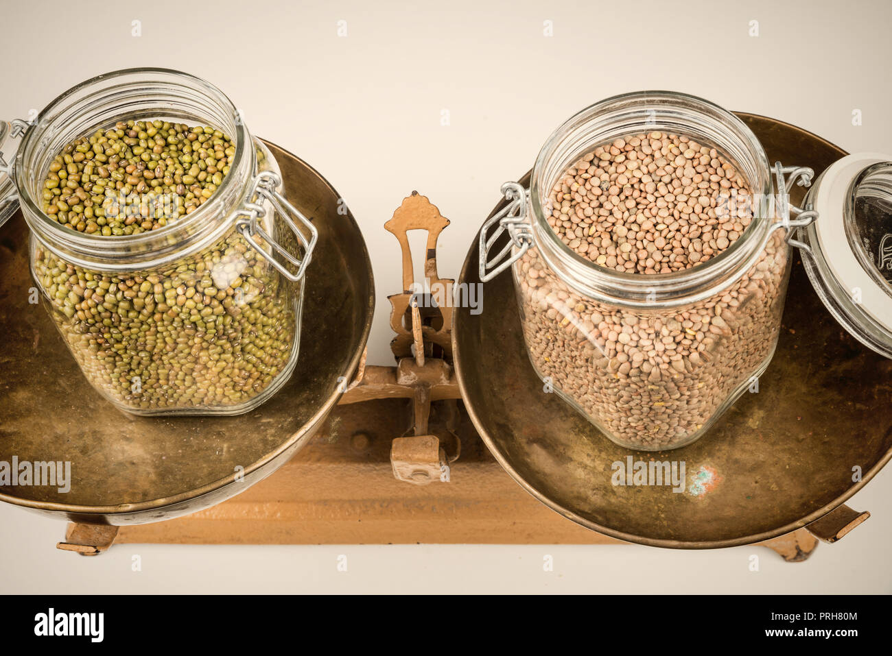 Jars with legumes on vintage scales, a healthy eating concept Stock ...