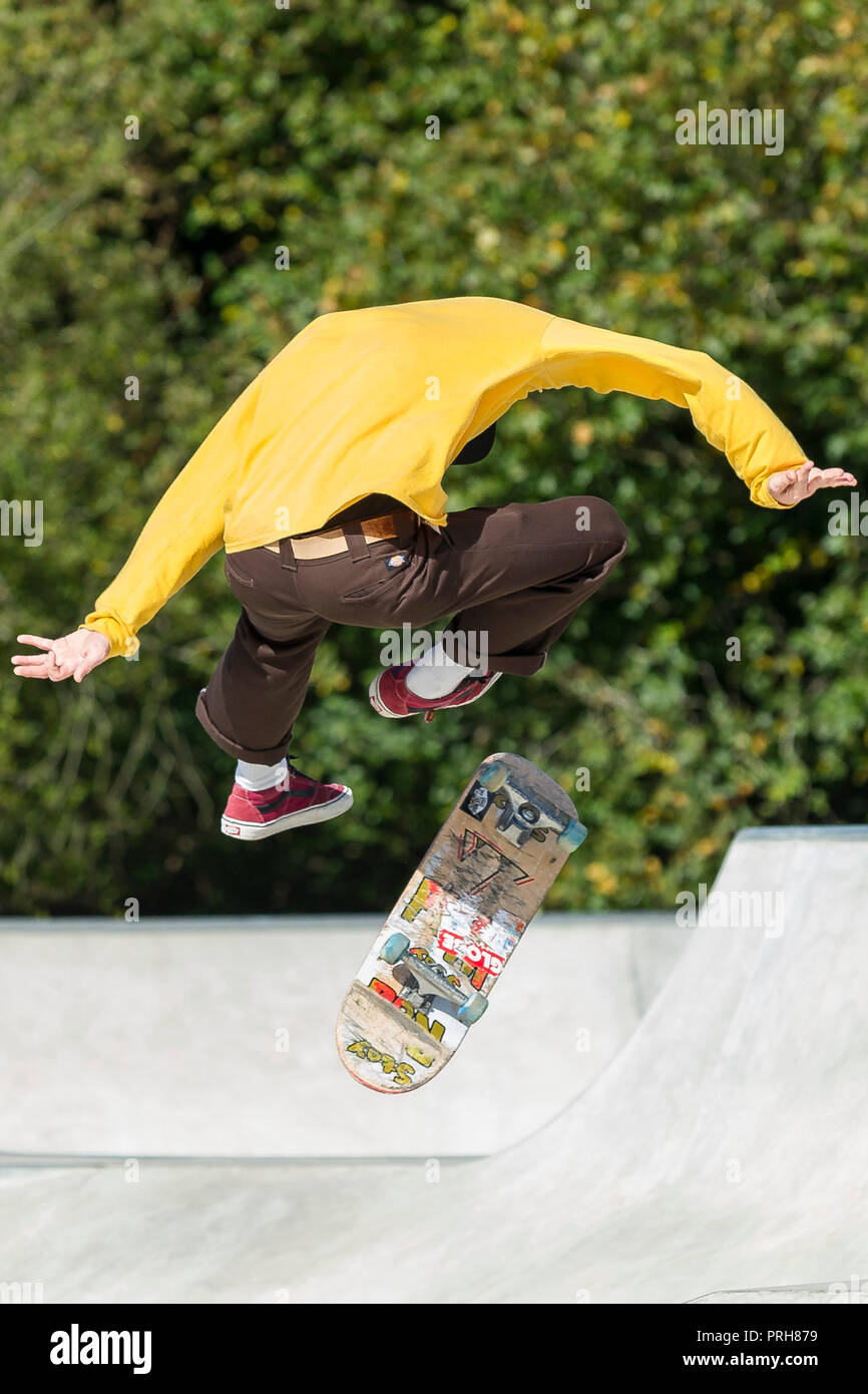 A skateboarder performing an aerial trick at Concrete Waves Skateboard ...