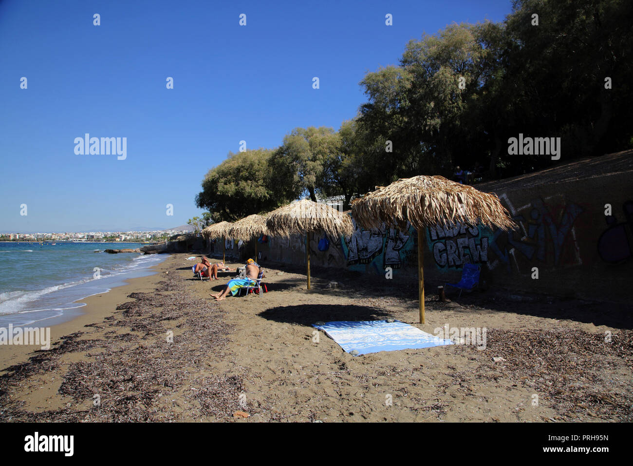 Vouliagmeni Greece Tourists on Kavouri Beach Stock Photo - Alamy