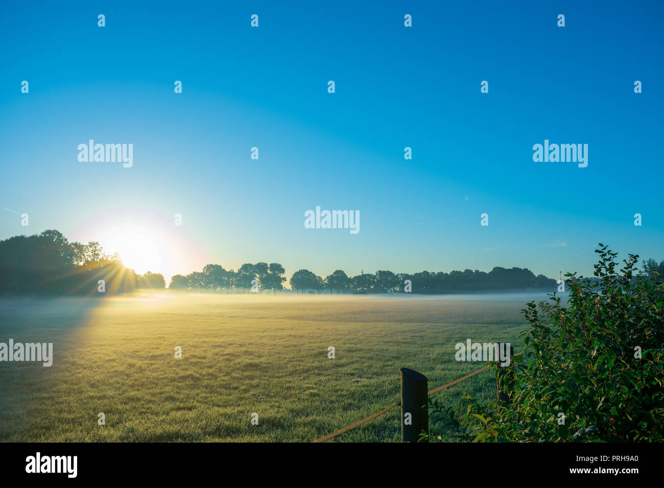 beautiful sunrise with morning mist on the fields. Location: Germany ...