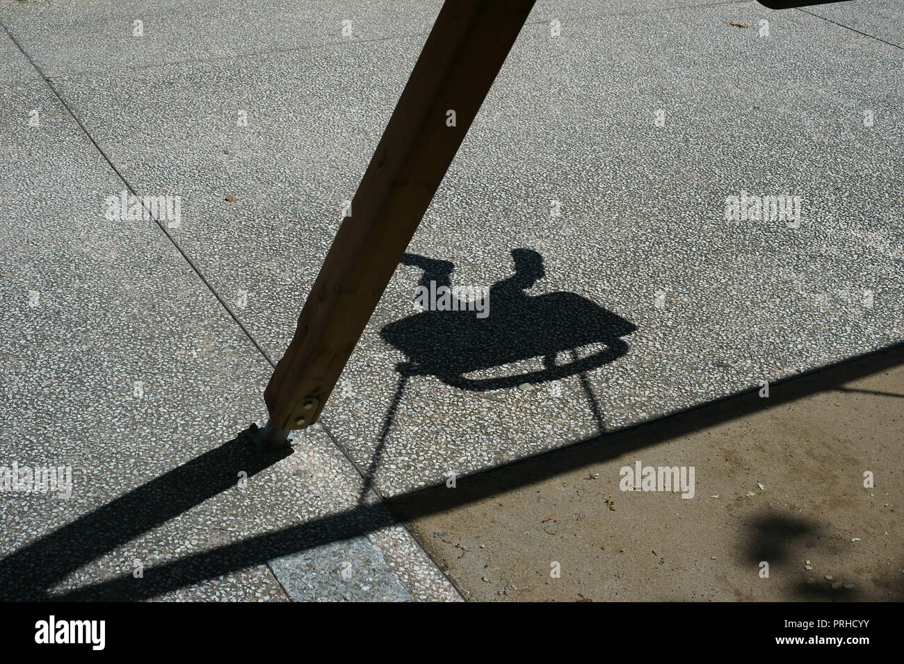 A shadow of a child on a swing Stock Photo - Alamy
