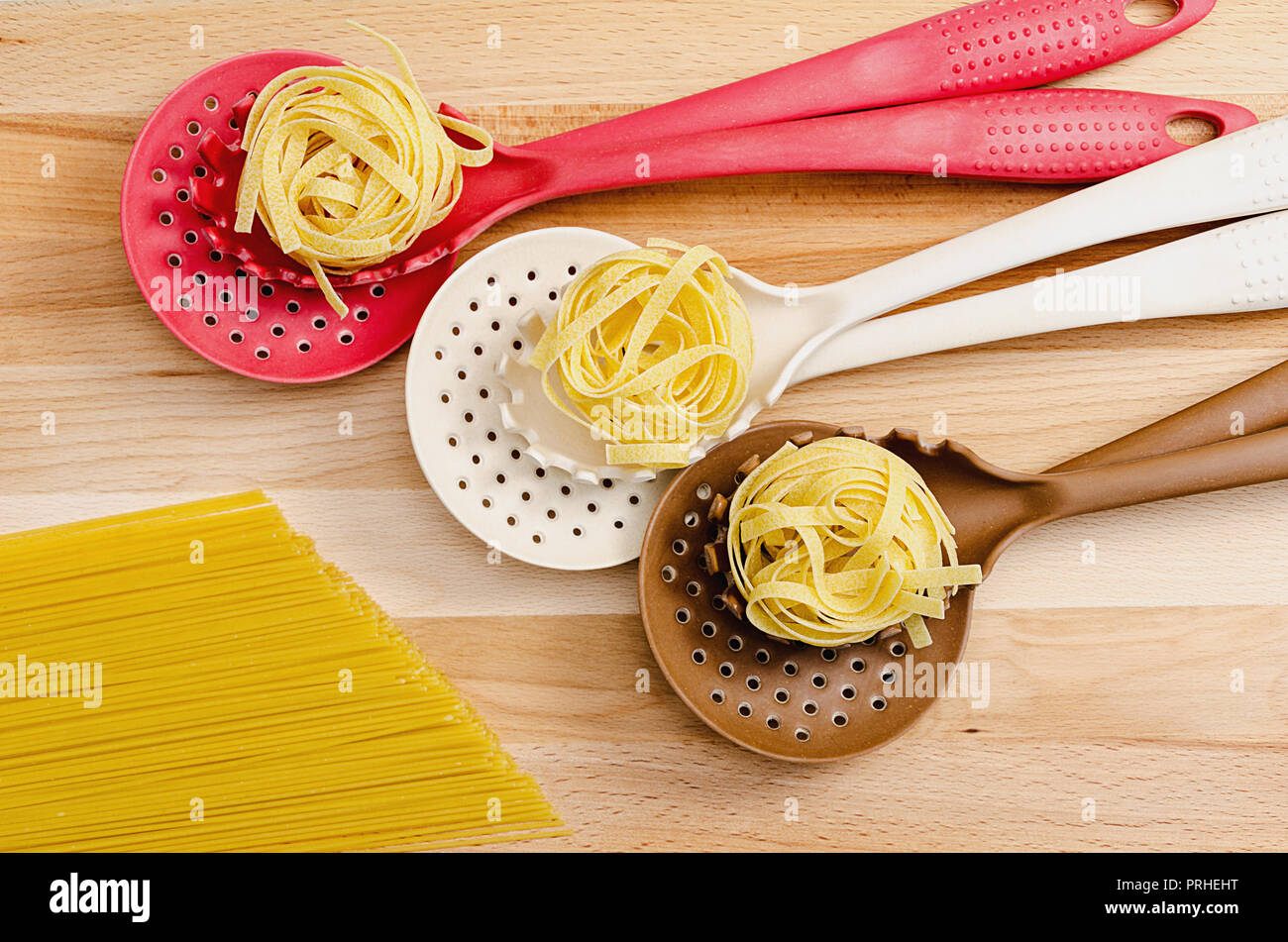 Homemade pasta in colander on wooden background Stock Photo - Alamy
