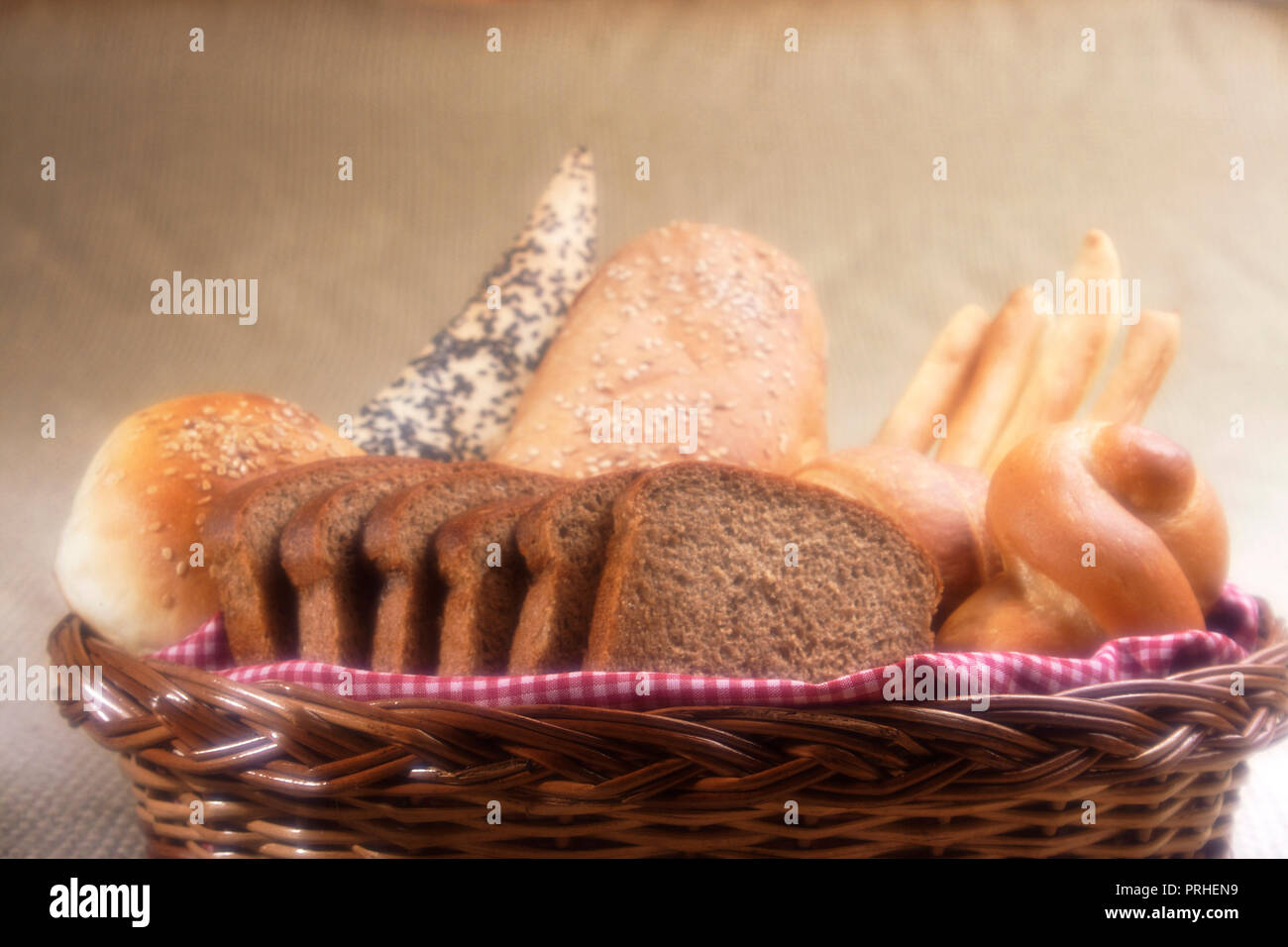 Assorted bread in a basket, soft focus Stock Photo - Alamy