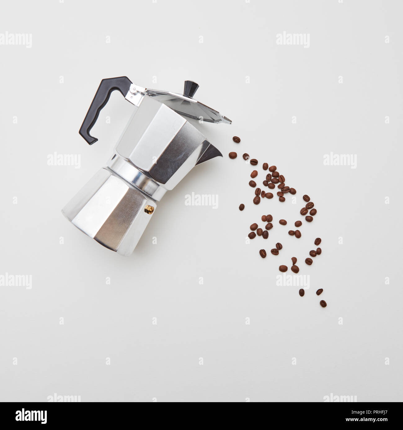Metal Italian coffee maker with coffee beans in the form of a poured ...