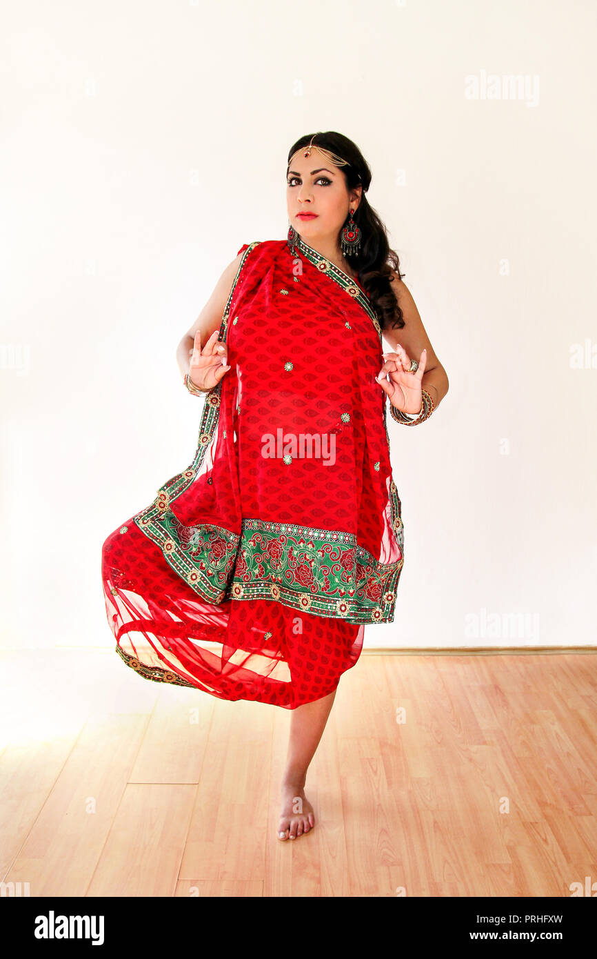Woman dancing Indian dance in national dress. A handsome beautiful girl ...