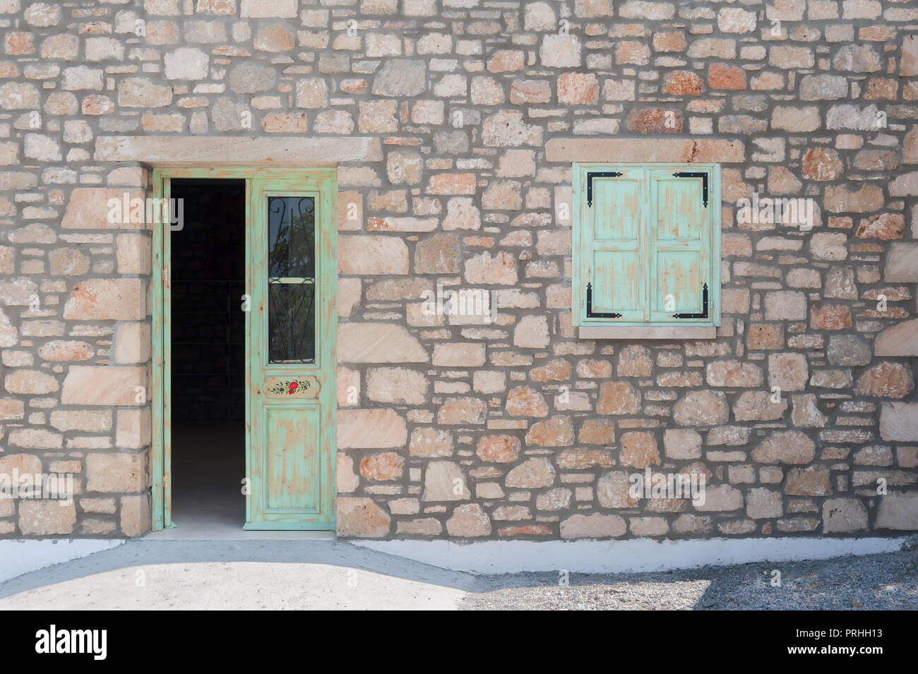 Traditional old masonry house with door and window. Old stone facade of ...