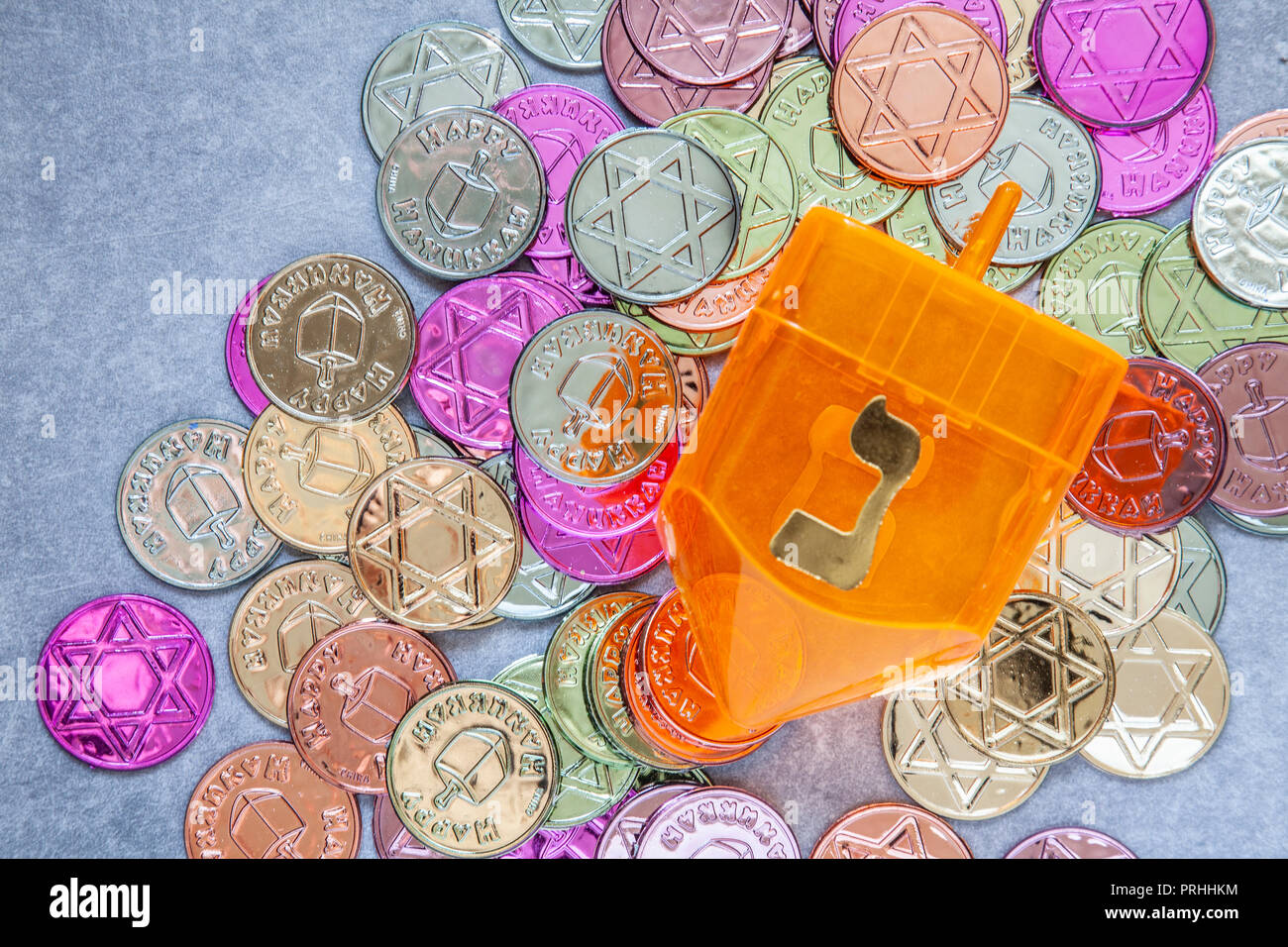 Large translucent orange plastic dreidl showing the Hebrew letter Nun ...