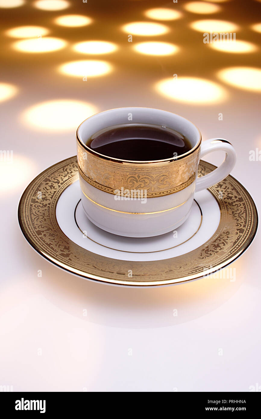 Regular Coffee in an ornate cup against a white background Stock Photo ...