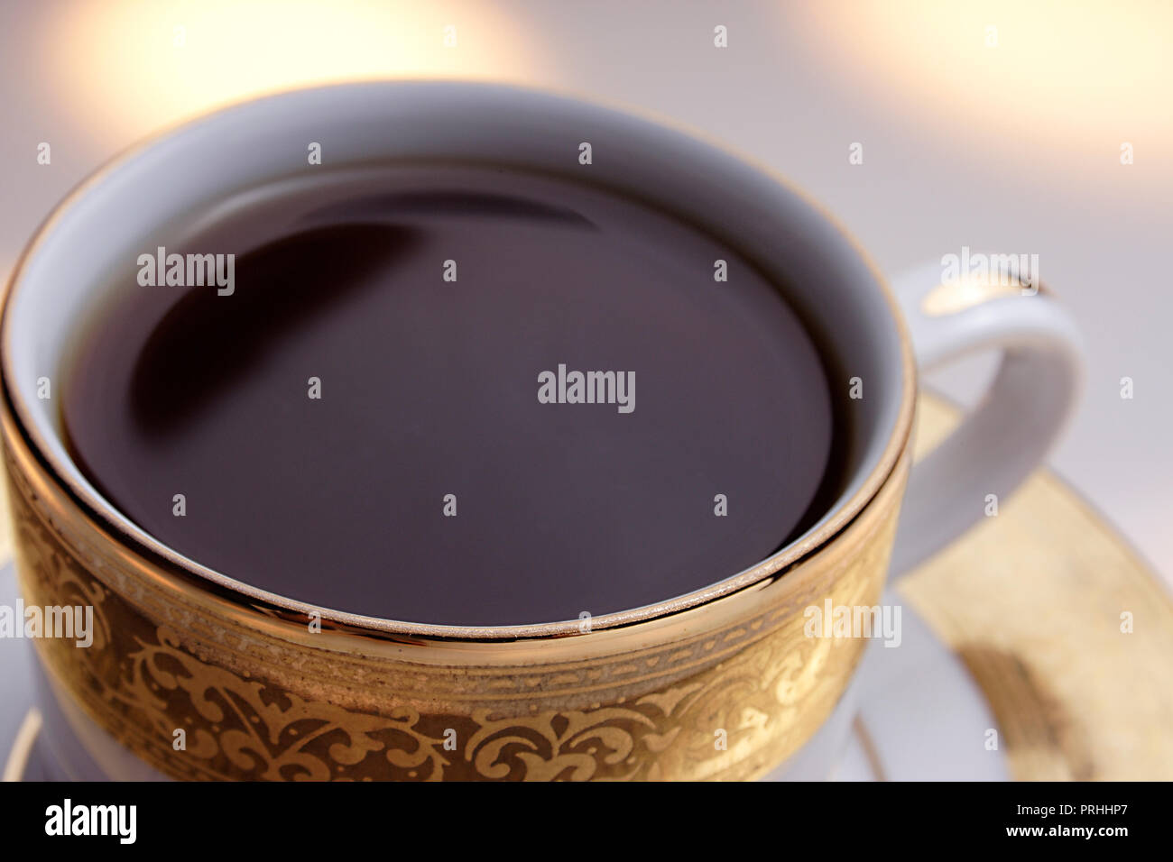Regular Coffee in an ornate cup against a white background Stock Photo ...