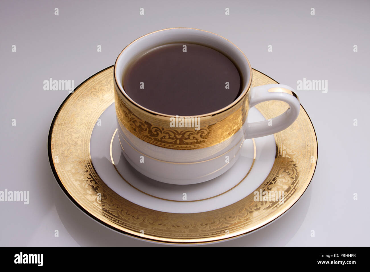 Regular Coffee in an ornate cup against a white background Stock Photo ...
