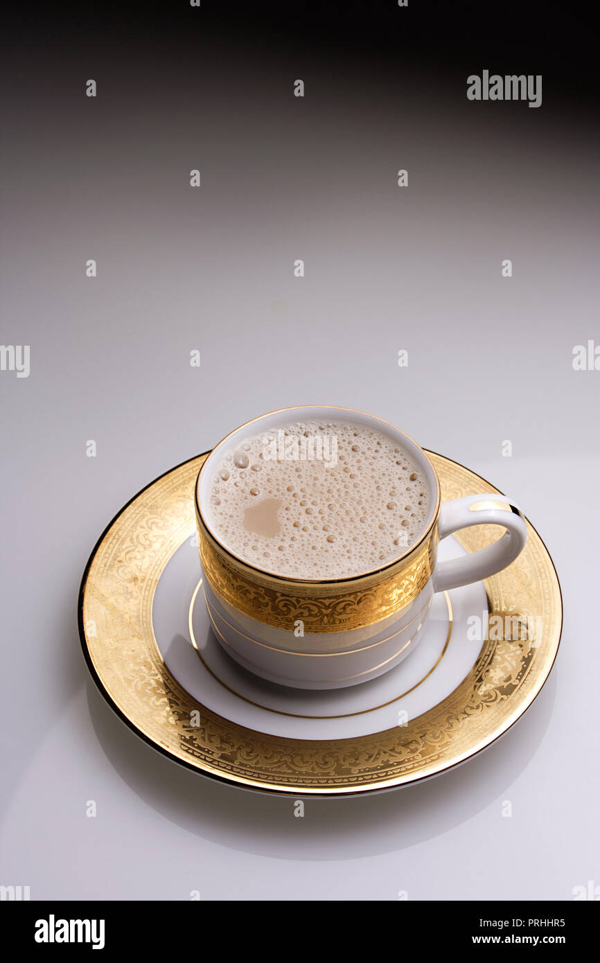 Regular Coffee in an ornate cup against a white background Stock Photo ...