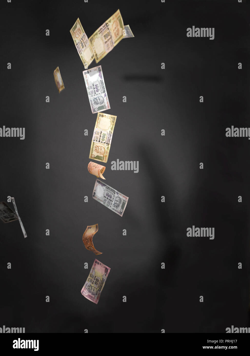 A STILL LIFE OF CURRENCY NOTES FLOATING AGAINST A PLAIN BACKGROUND ...