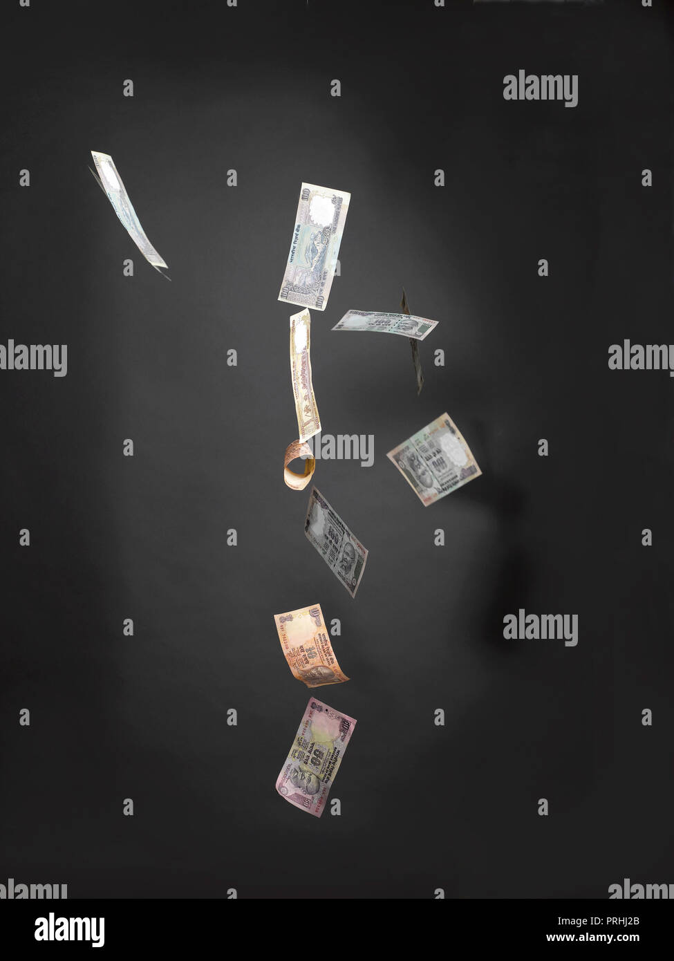 A STILL LIFE OF CURRENCY NOTES FLOATING AGAINST A PLAIN BACKGROUND ...