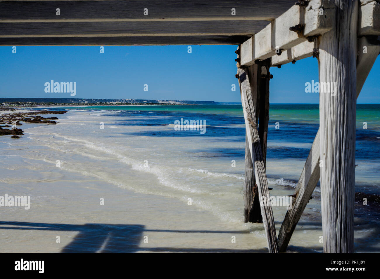 The ruins of the old historic wooden jetty on the coastline at Eucla ...