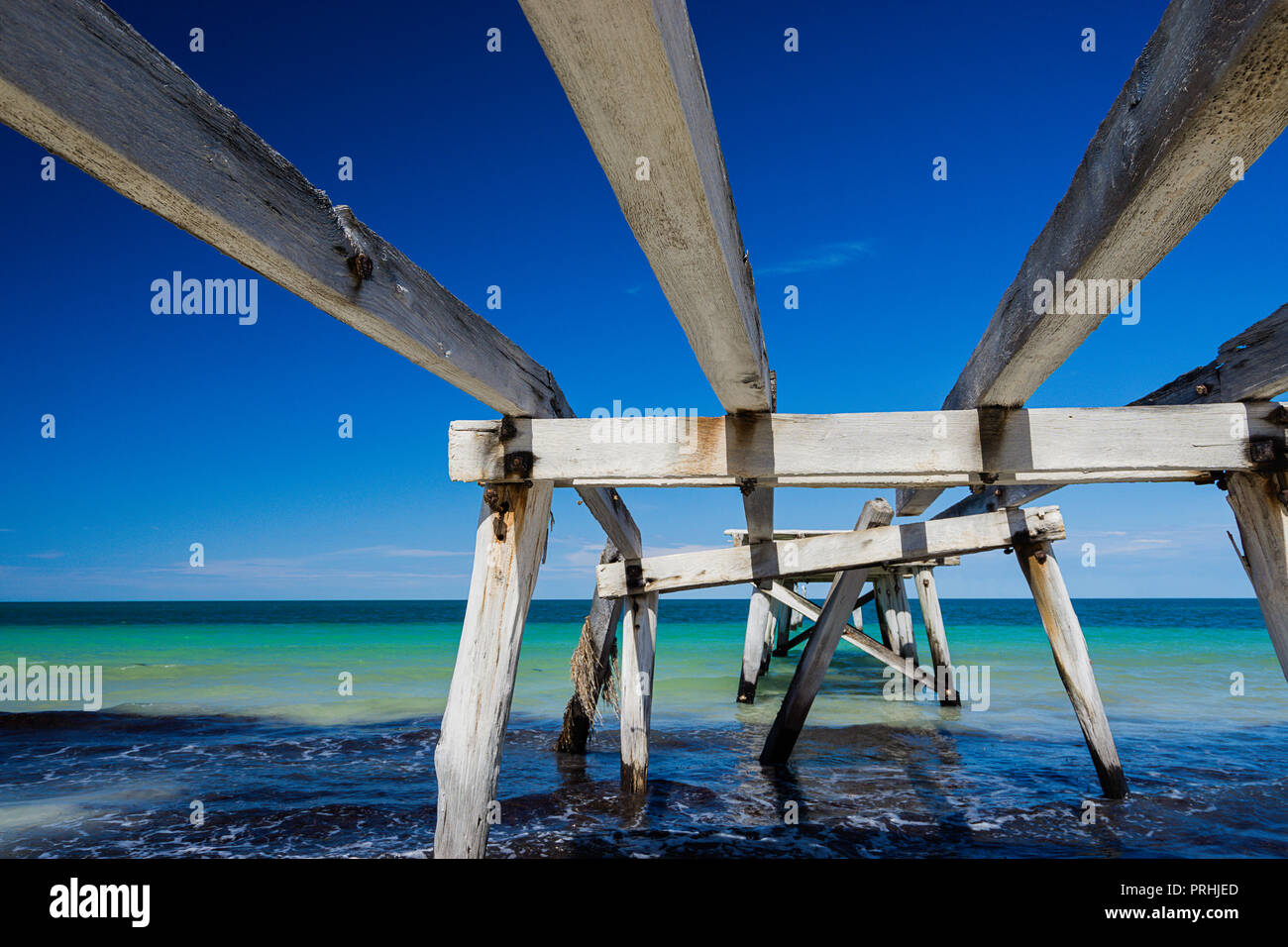 The ruins of the old historic wooden jetty on the coastline at Eucla ...