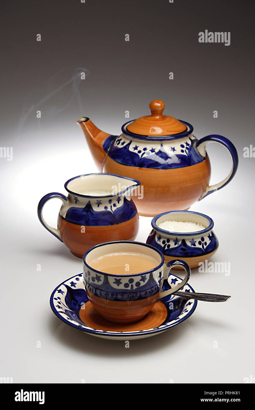 Masala Tea Chai hot in an ethnic tea set on a white background Stock ...