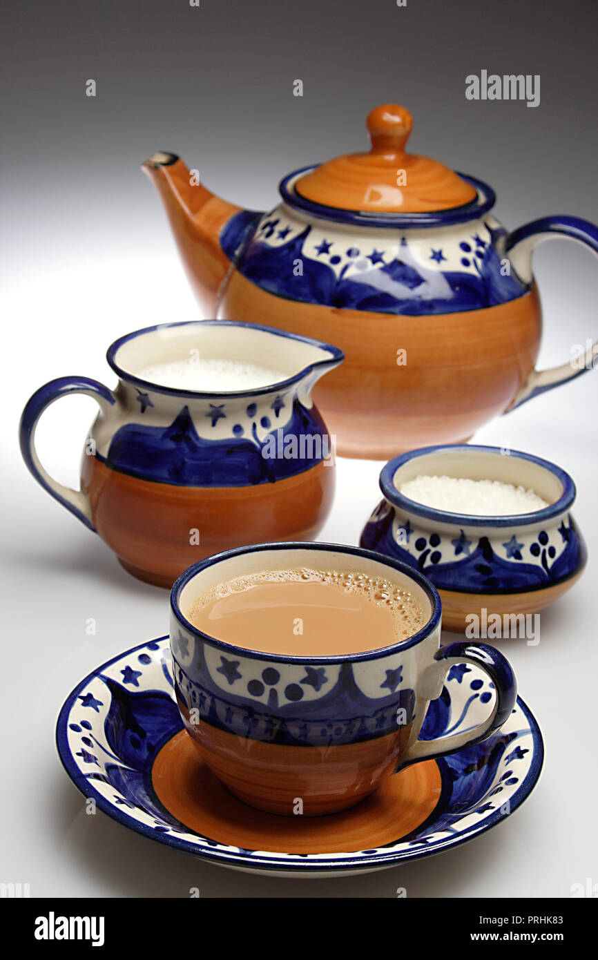 Masala Tea Chai hot in an ethnic tea set on a white background Stock ...
