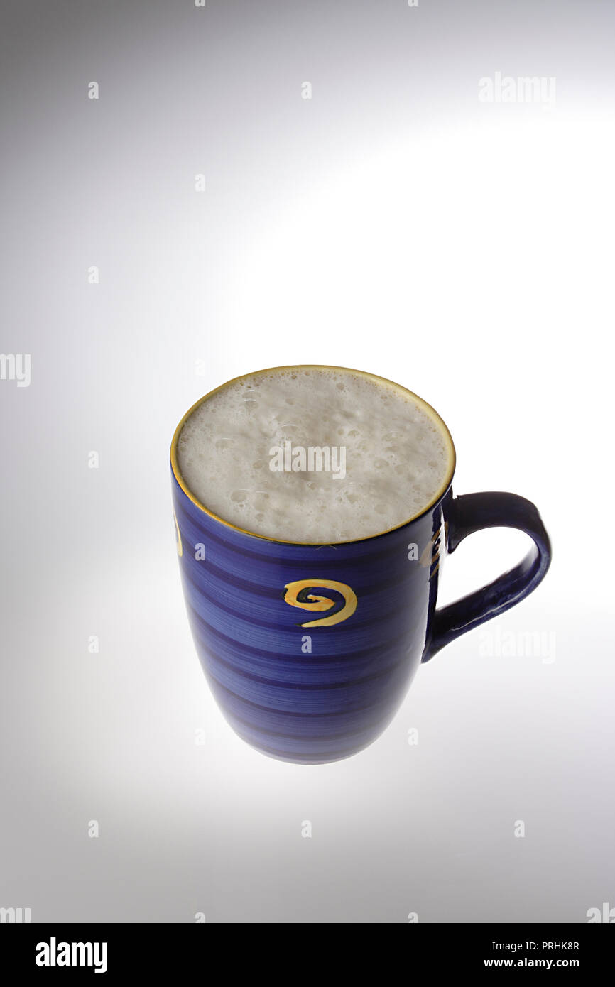 Milk in a mug on a white background Stock Photo - Alamy