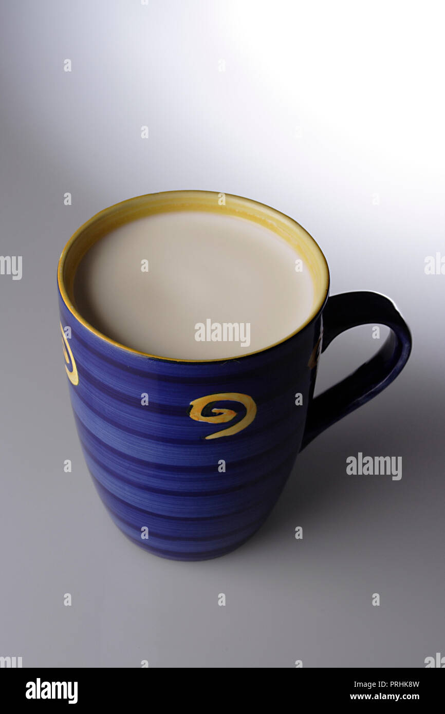 Milk in a mug on a white background Stock Photo - Alamy