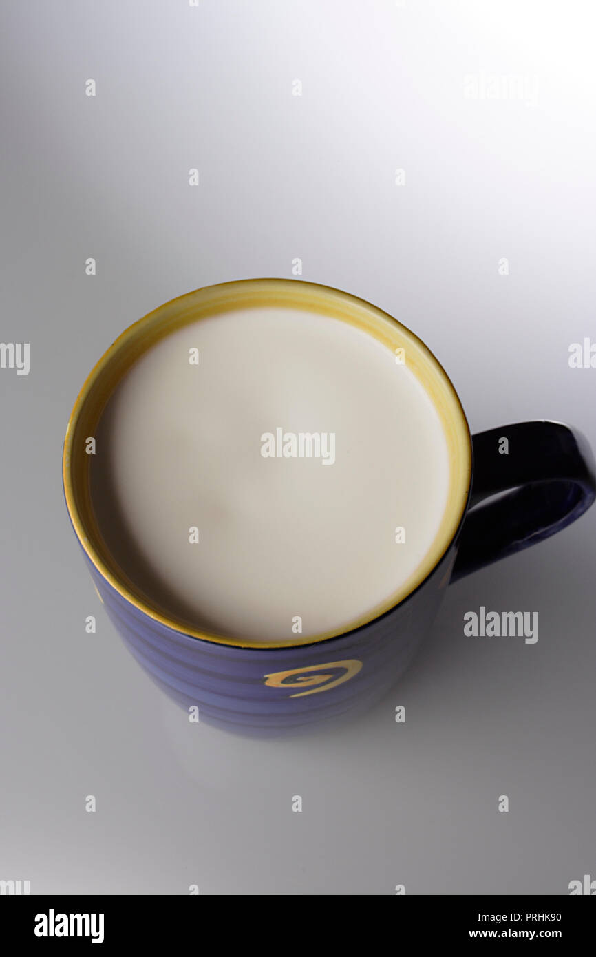 Milk in a mug on a white background Stock Photo - Alamy