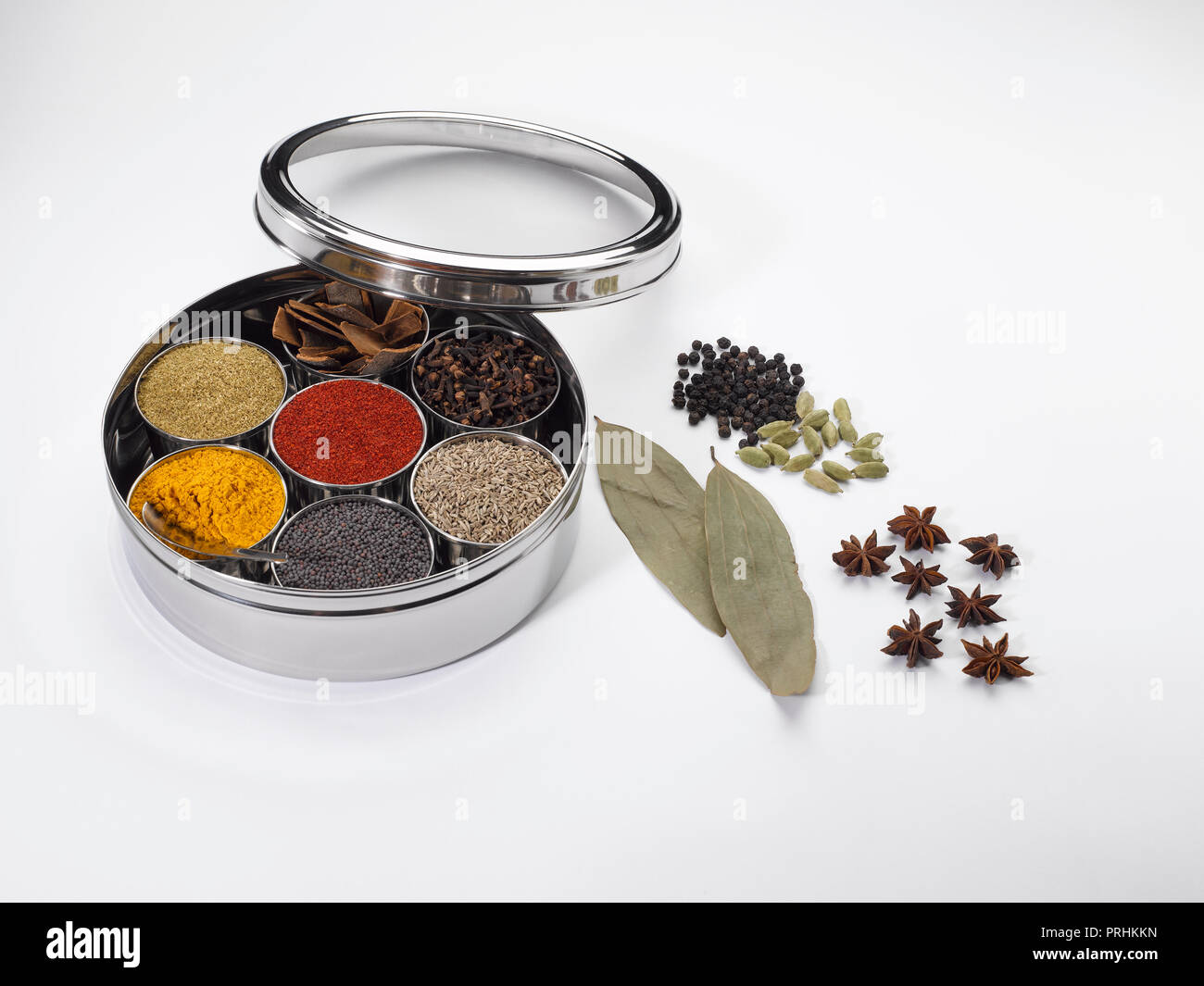Stainless masala dabba on a white background Stock Photo - Alamy