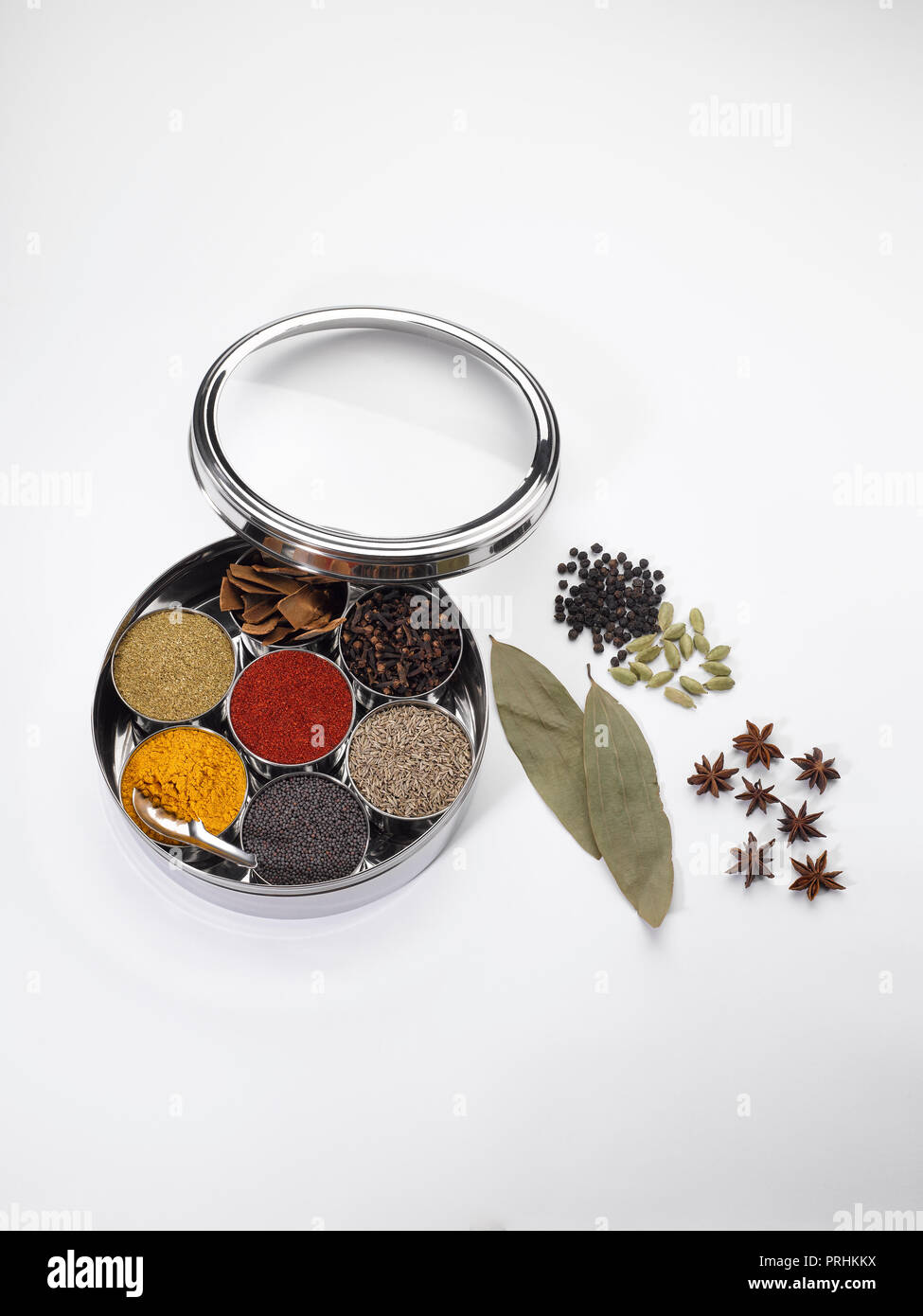 Stainless masala dabba on a white background Stock Photo - Alamy
