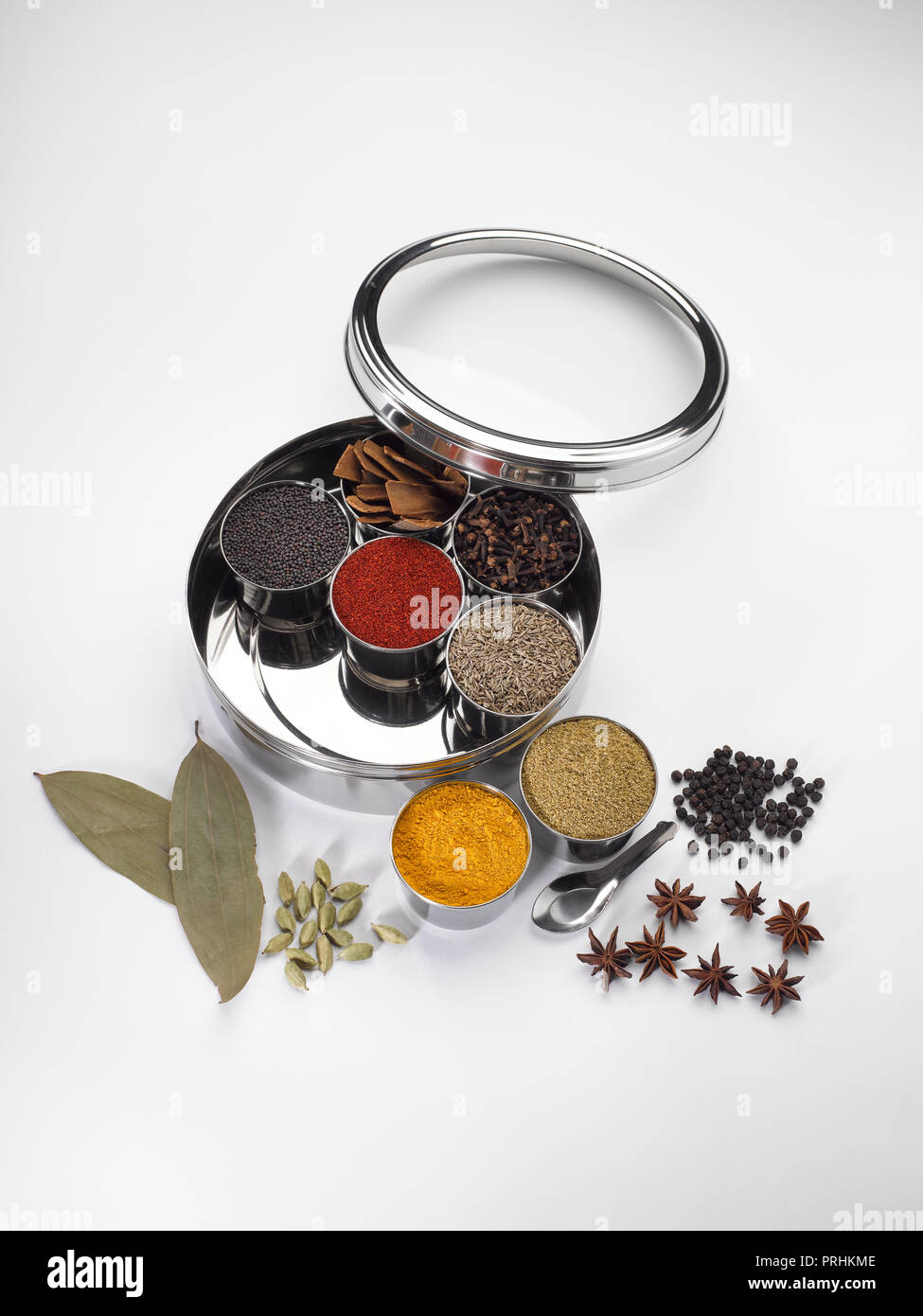 Stainless masala dabba on a white background Stock Photo - Alamy