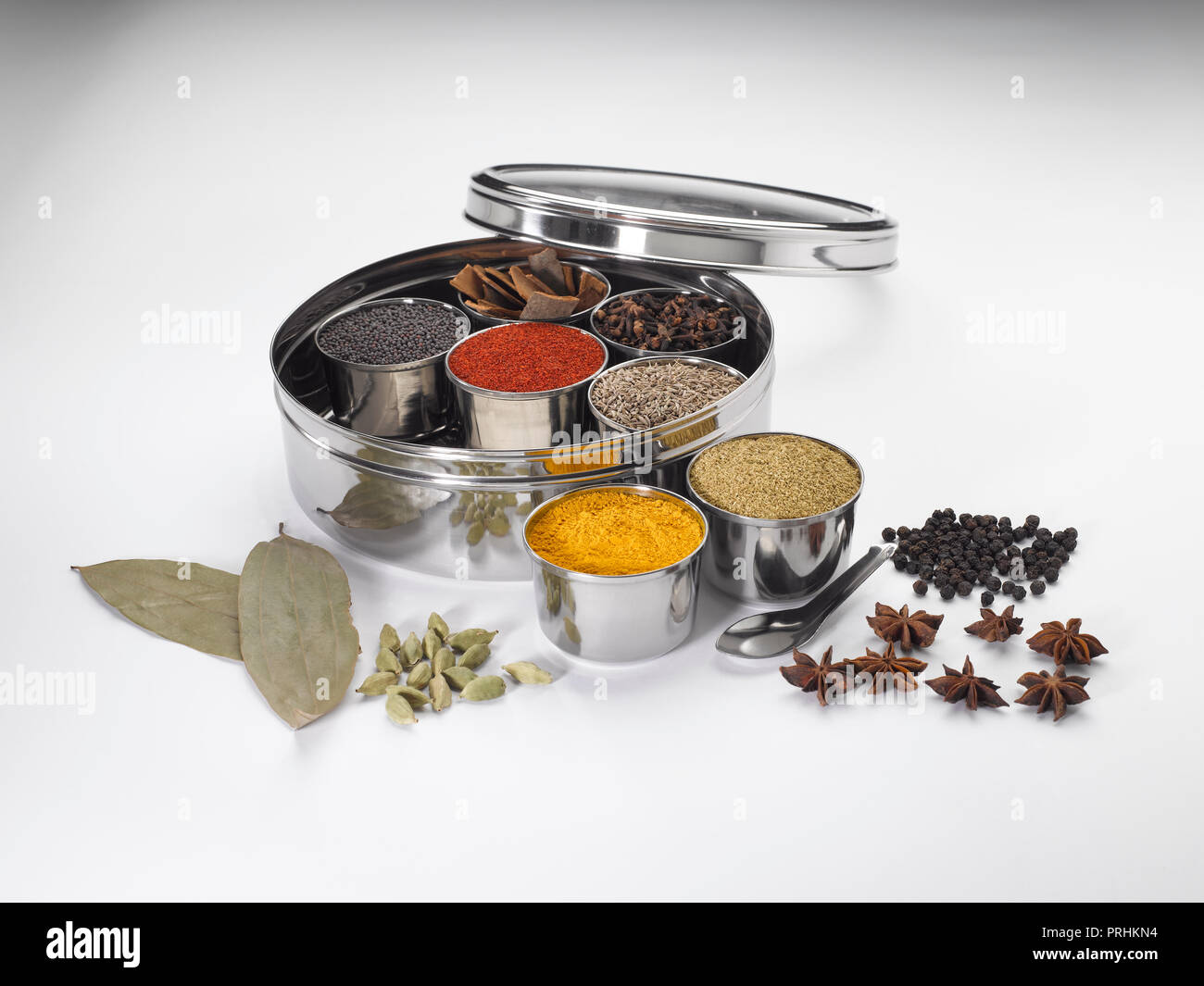Stainless masala dabba on a white background Stock Photo - Alamy