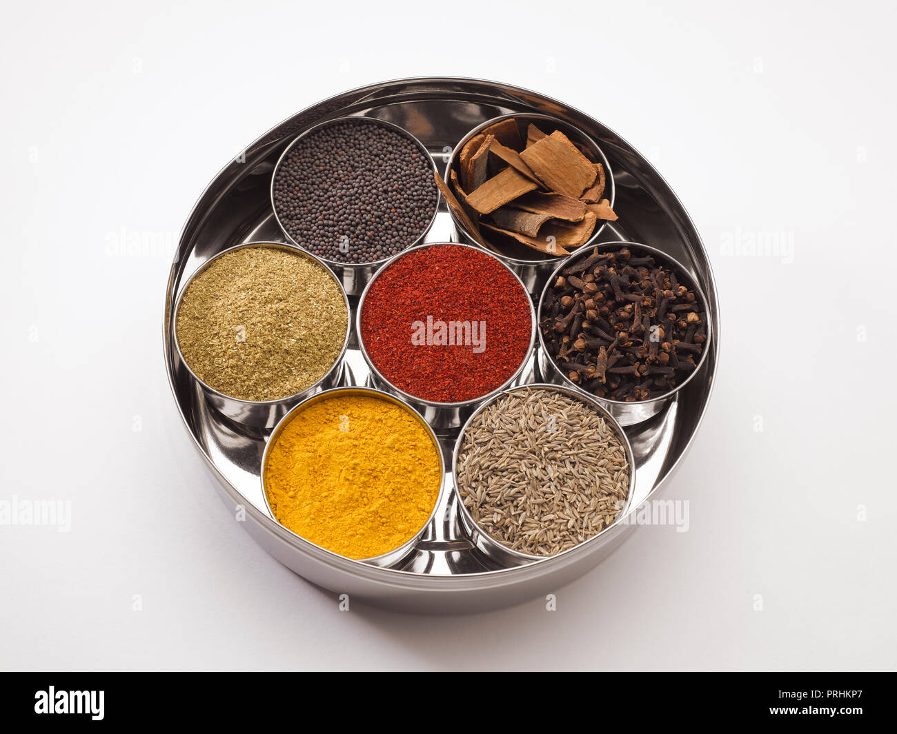 Stainless masala dabba on a white background Stock Photo - Alamy