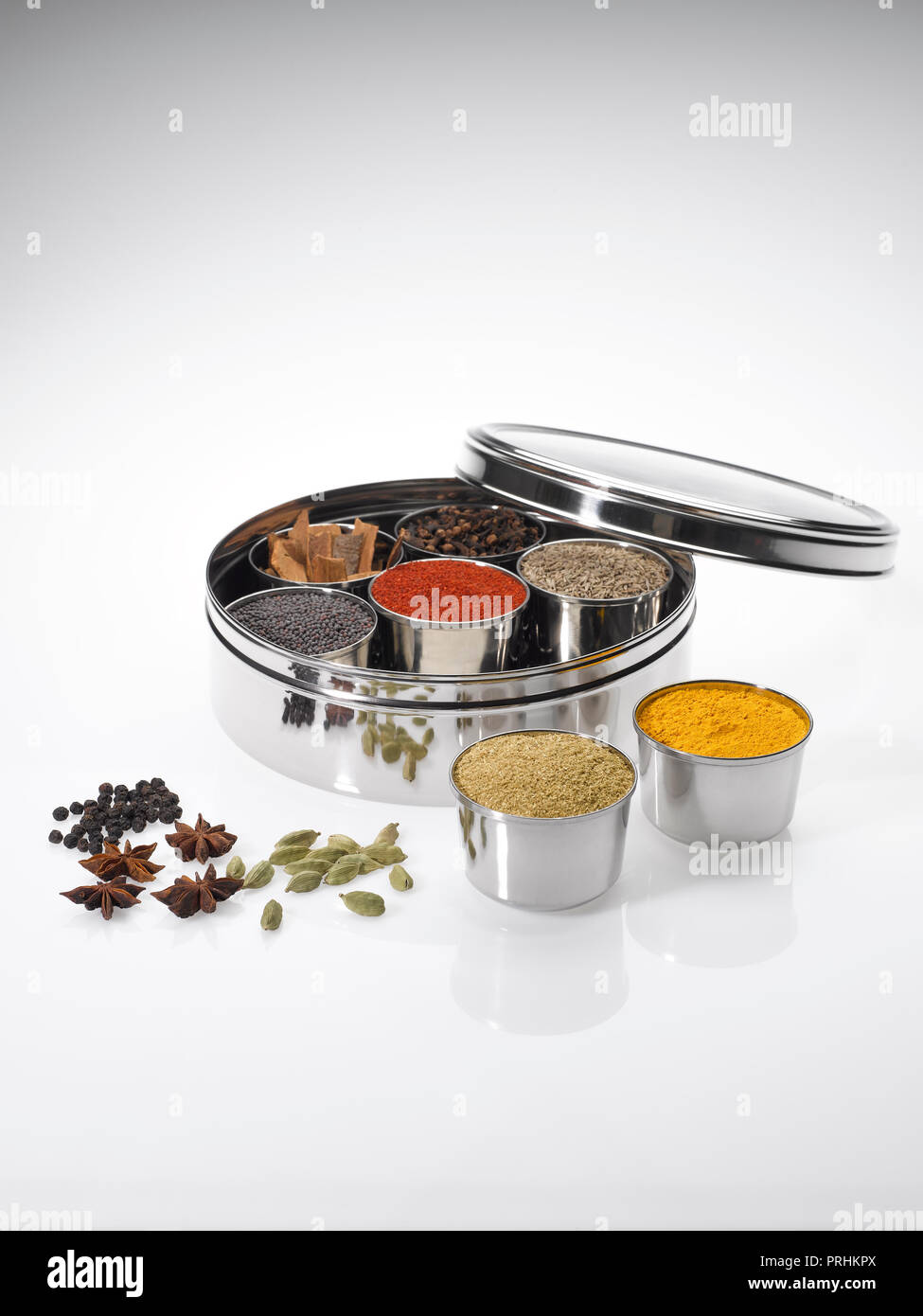 Stainless masala dabba on a white background Stock Photo - Alamy