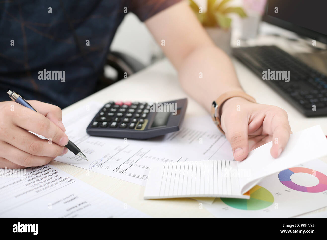 Man is checking account with pen, calculator and notepad Stock Photo ...