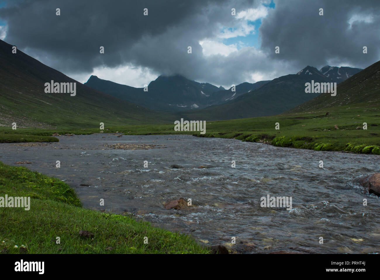 Glacial stream running through the mountains Stock Photo - Alamy