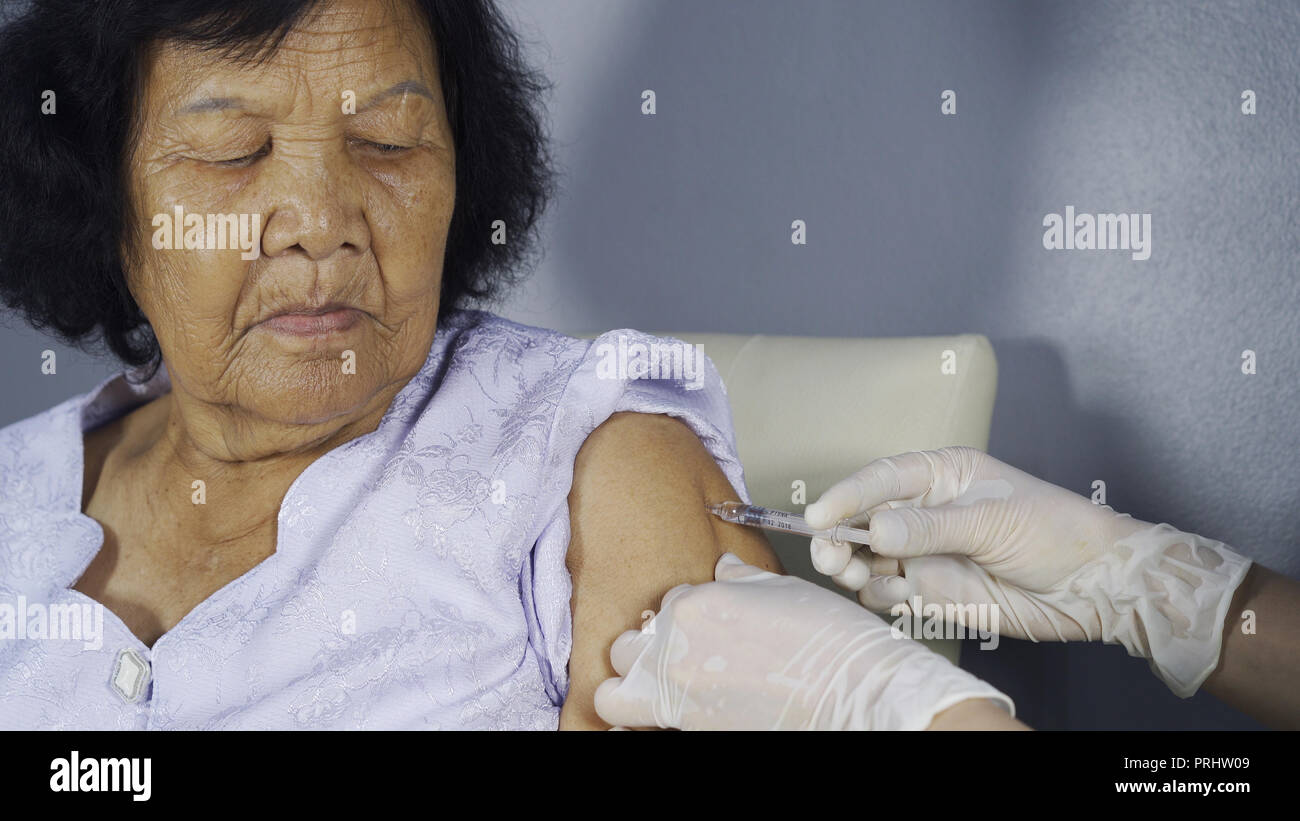 Doctor giving woman injection hi-res stock photography and images - Alamy