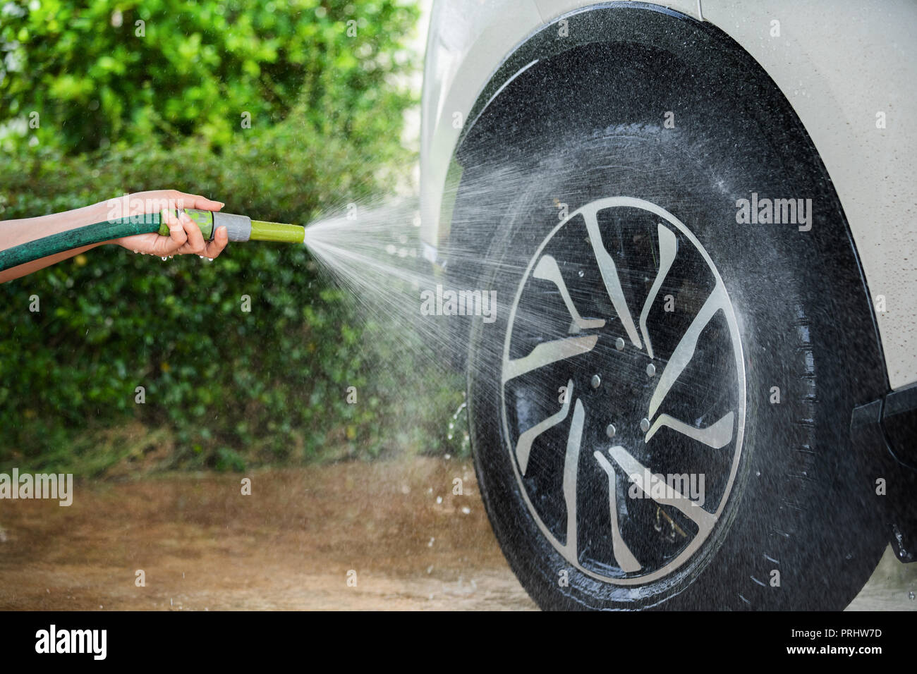 car wheel washing with a spray water Stock Photo - Alamy
