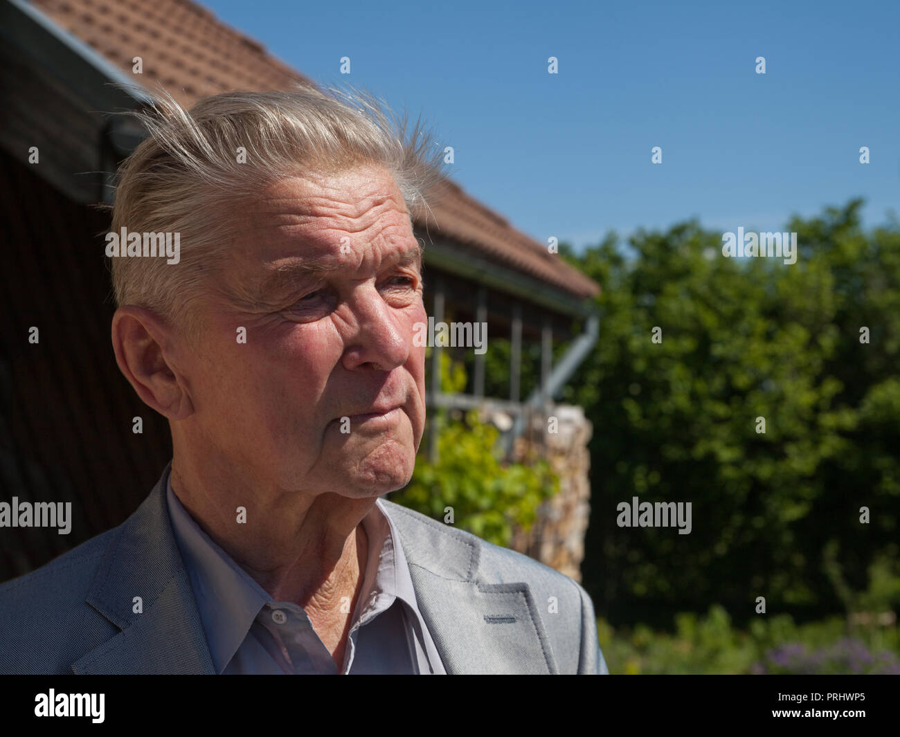 Happy old man in yard at the his house Stock Photo - Alamy