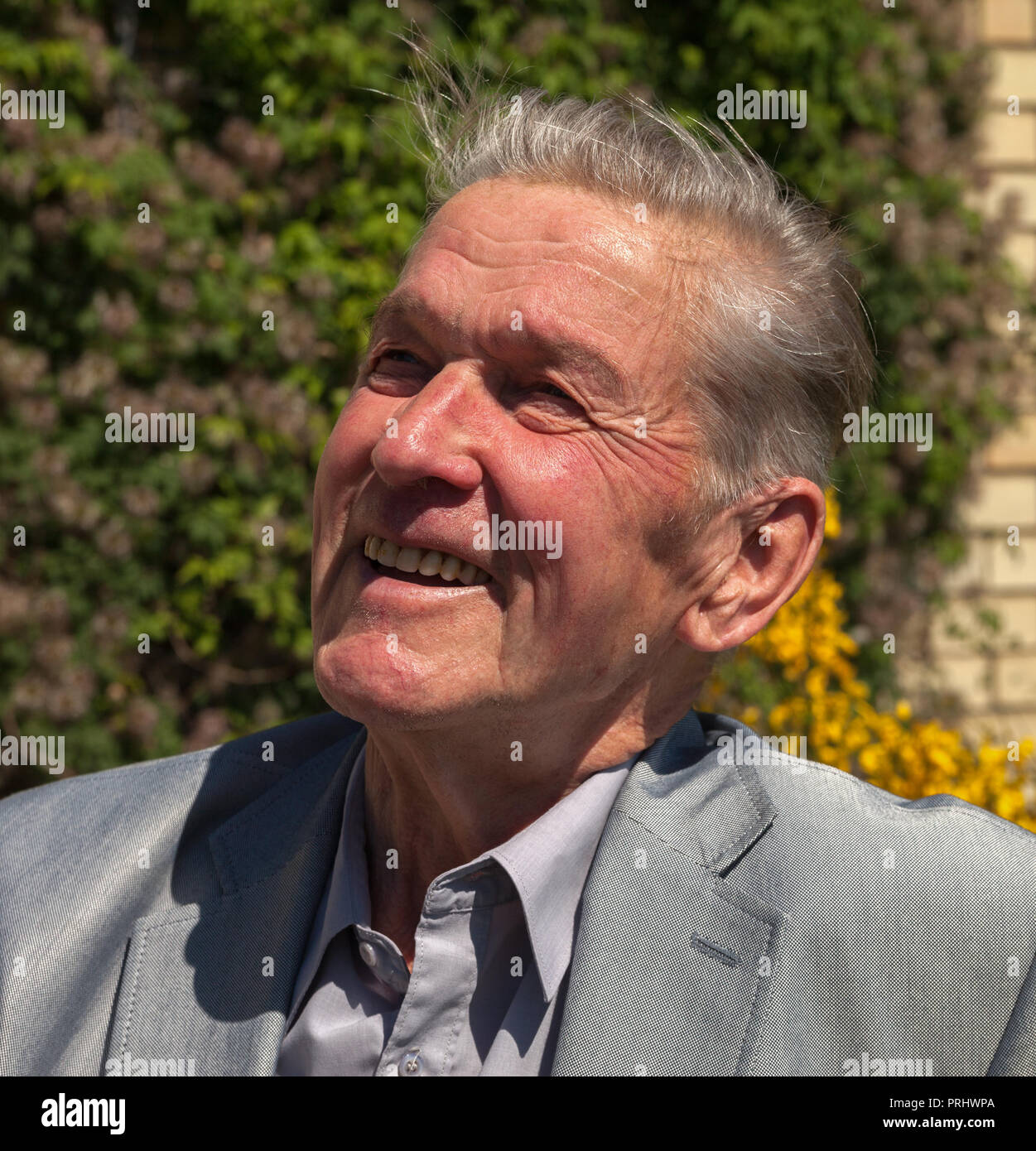 Happy old man in yard at the his house Stock Photo - Alamy
