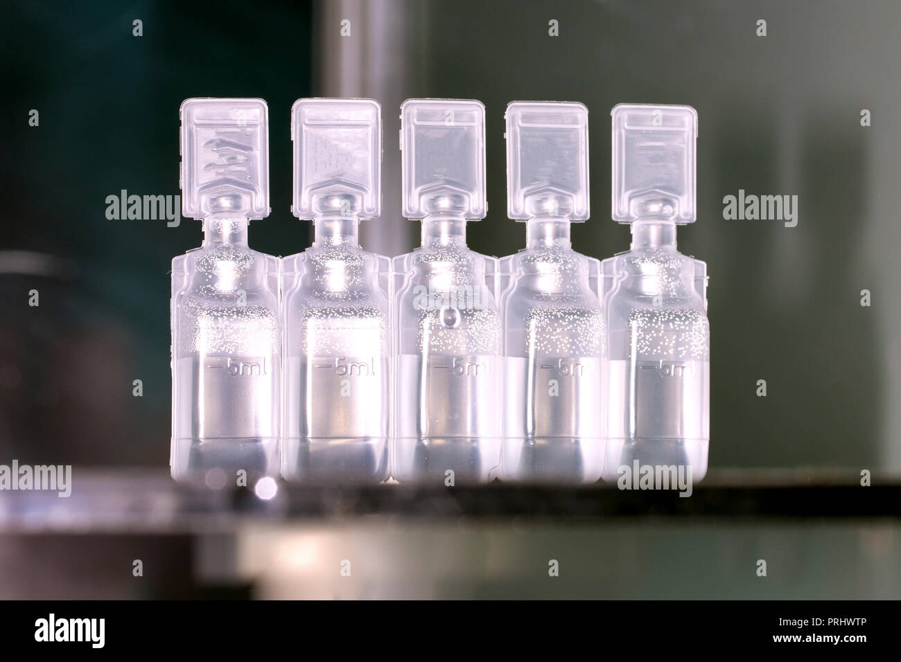 five ml of a container with a medical preparation, a background image ...