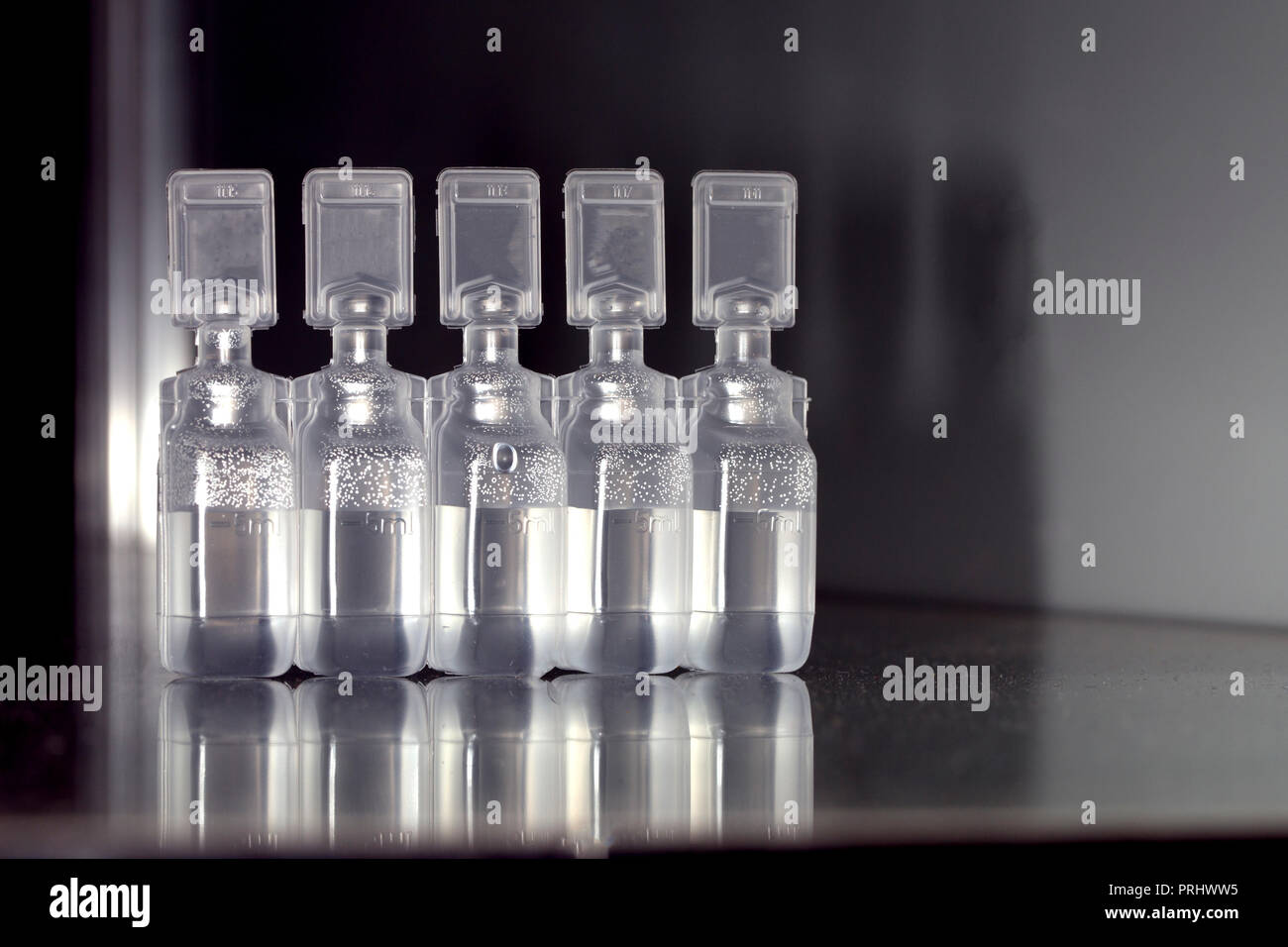 five ml of a container with a medical preparation, a background image ...