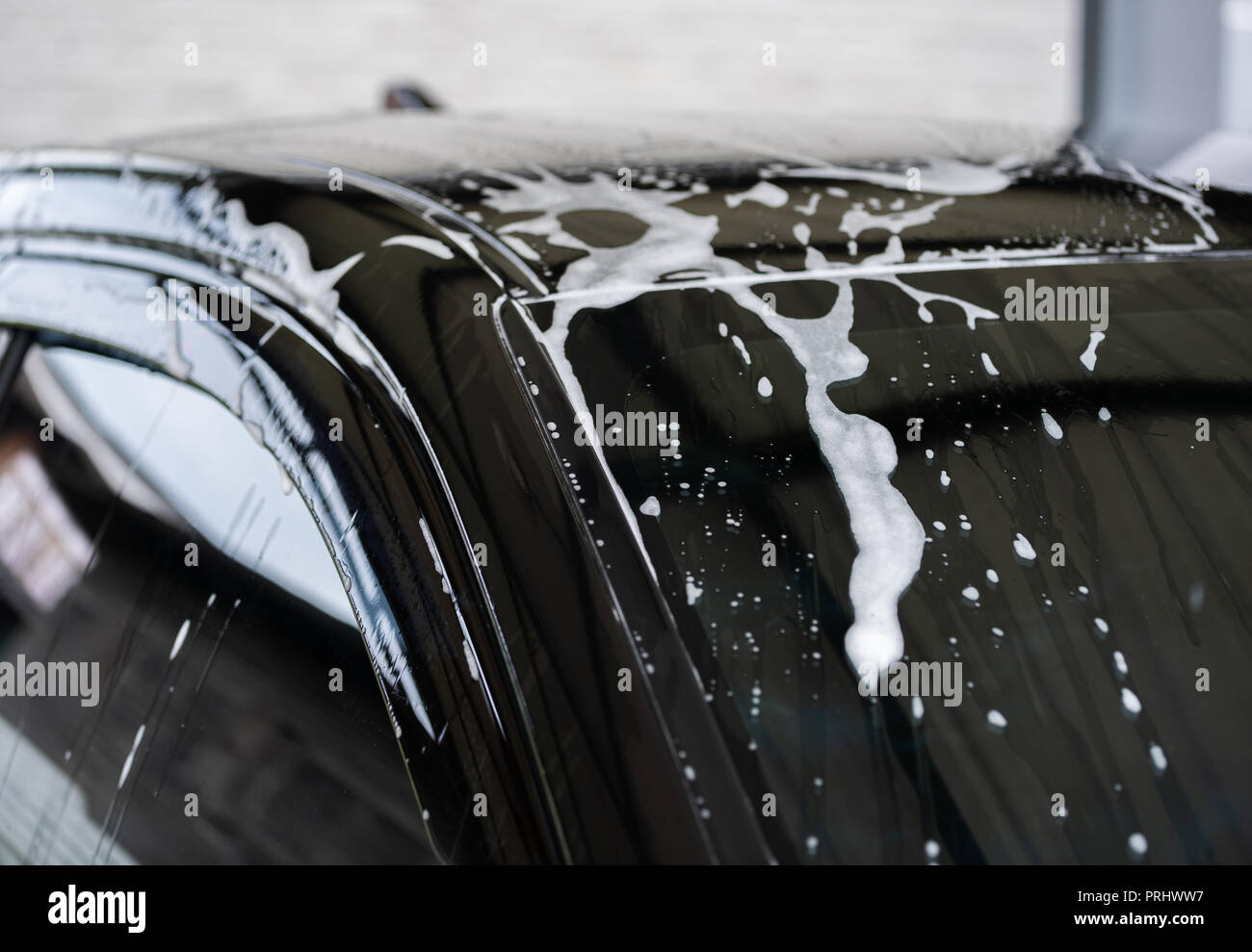 car washing with a foam on roof top Stock Photo - Alamy