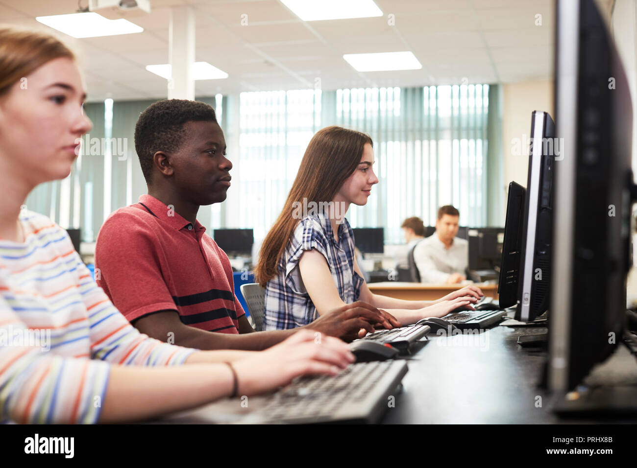 Group Of High School Students Working Together In Computer Class Stock ...