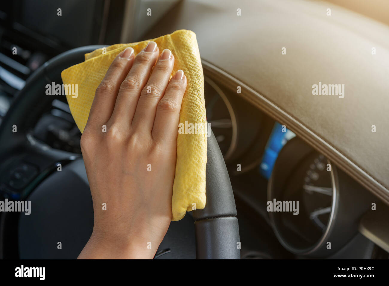 hand cleaning steering wheel of car with yellow microfiber cloth Stock ...