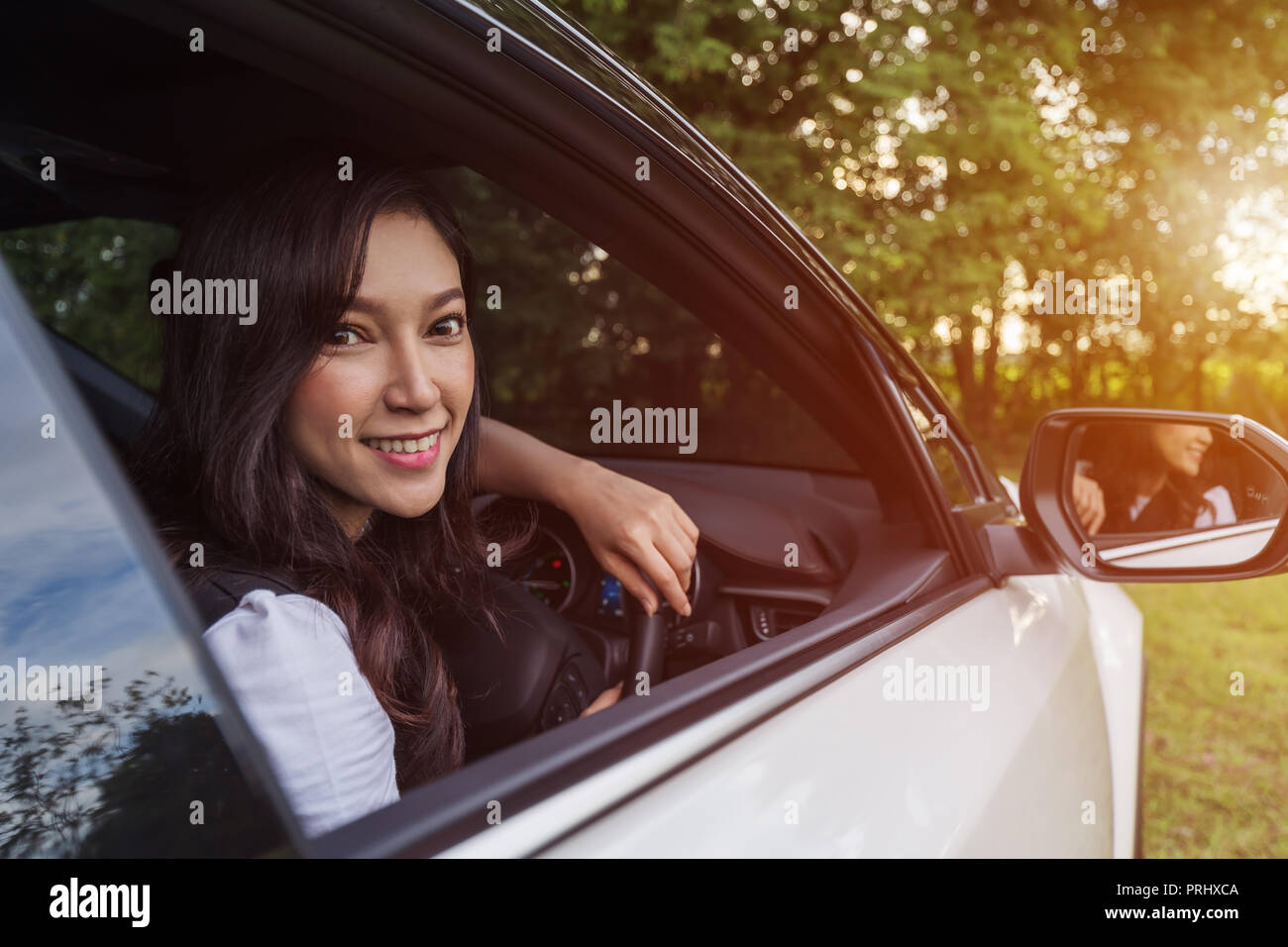 Young woman driving car in sunlight hi-res stock photography and images ...