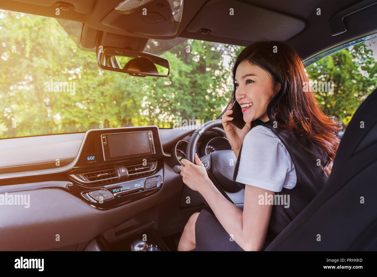 woman driving a car and talking on mobile phone Stock Photo - Alamy