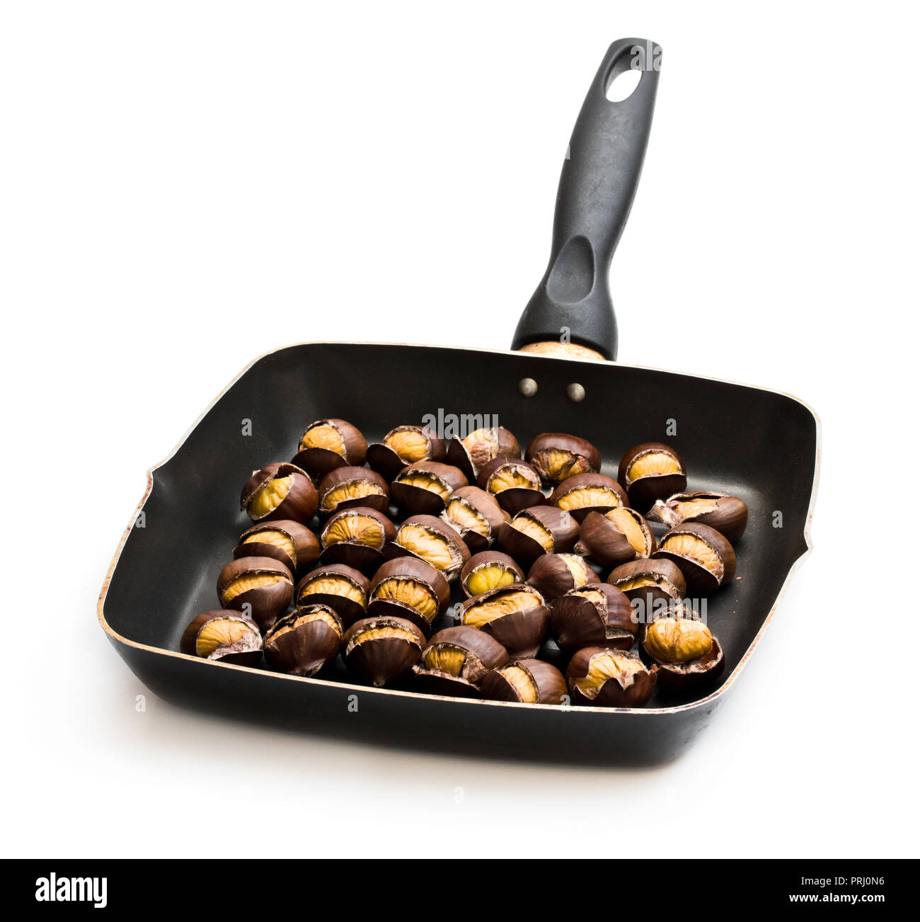 Roasted chestnuts in frying pan isolated on white Stock Photo - Alamy