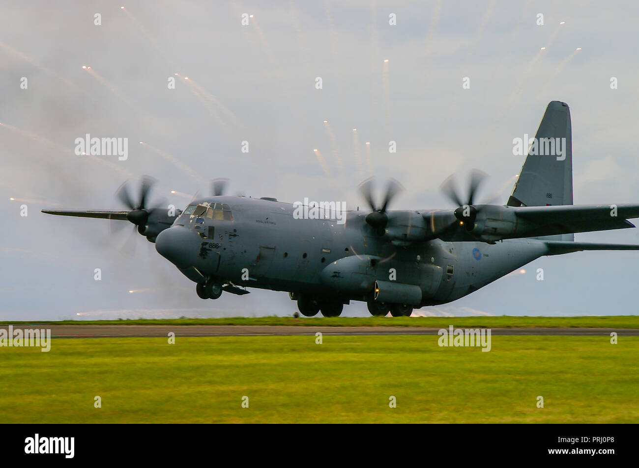 RAF, Royal Air Force Hercules transport plane taking off with explosion ...