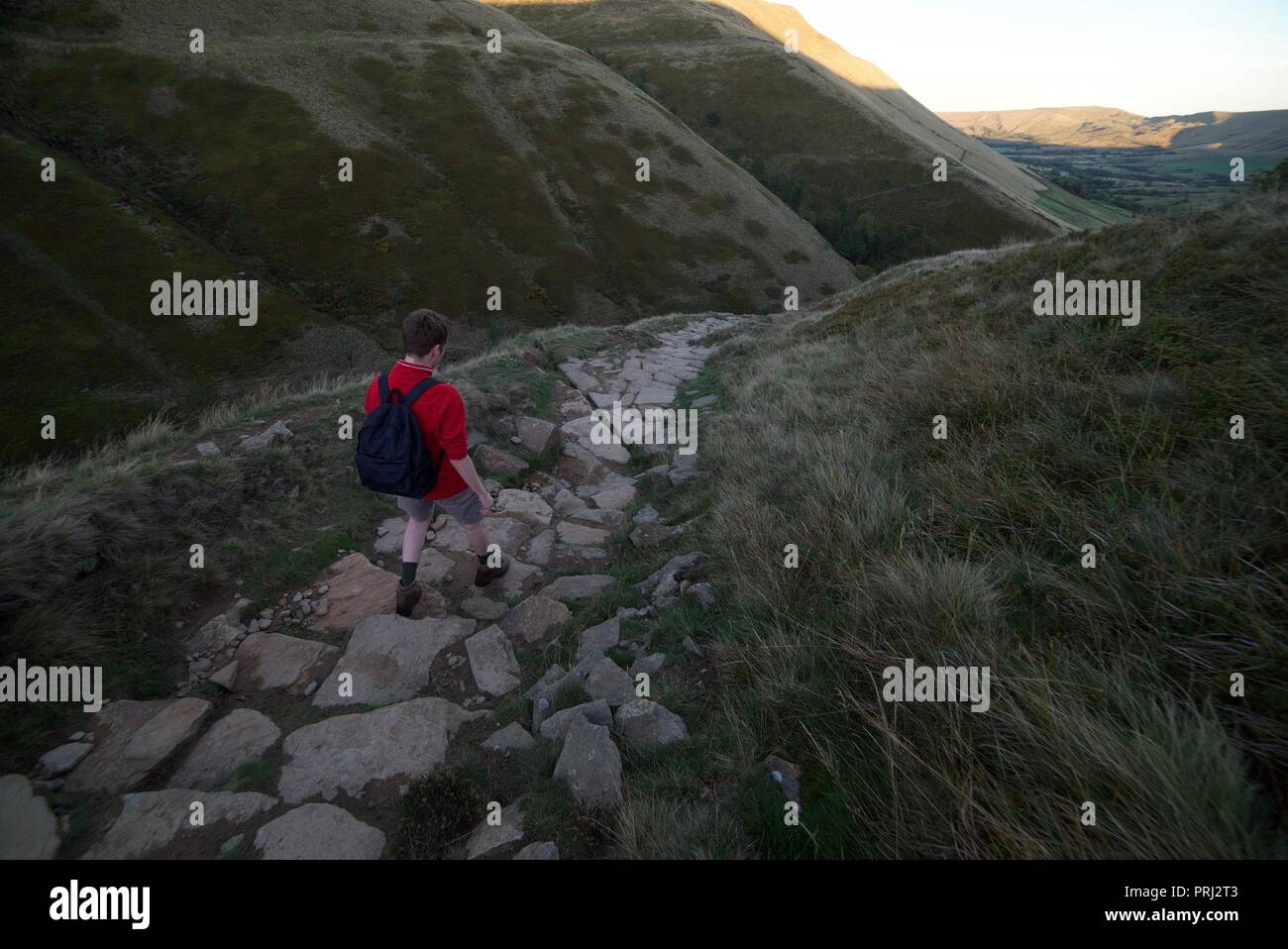 Hiker walking down the Jacob's Ladder footpath near Kinder Scout, Edale ...